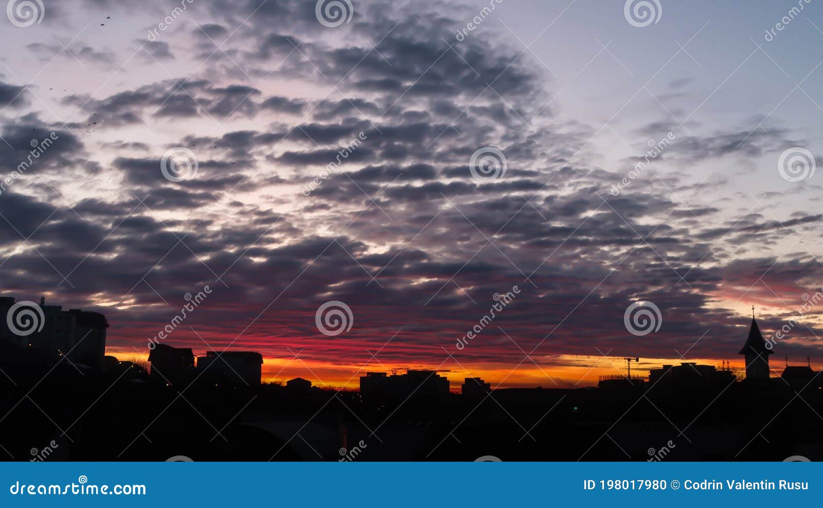 Cloudy Fire Sunrise with Backlit Buildings and Cloudy Sky. Landscape of ...