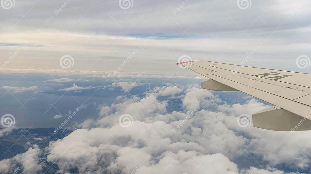 Cloudy Horizon in Haze Under the Wing of an Airplane Stock Image ...