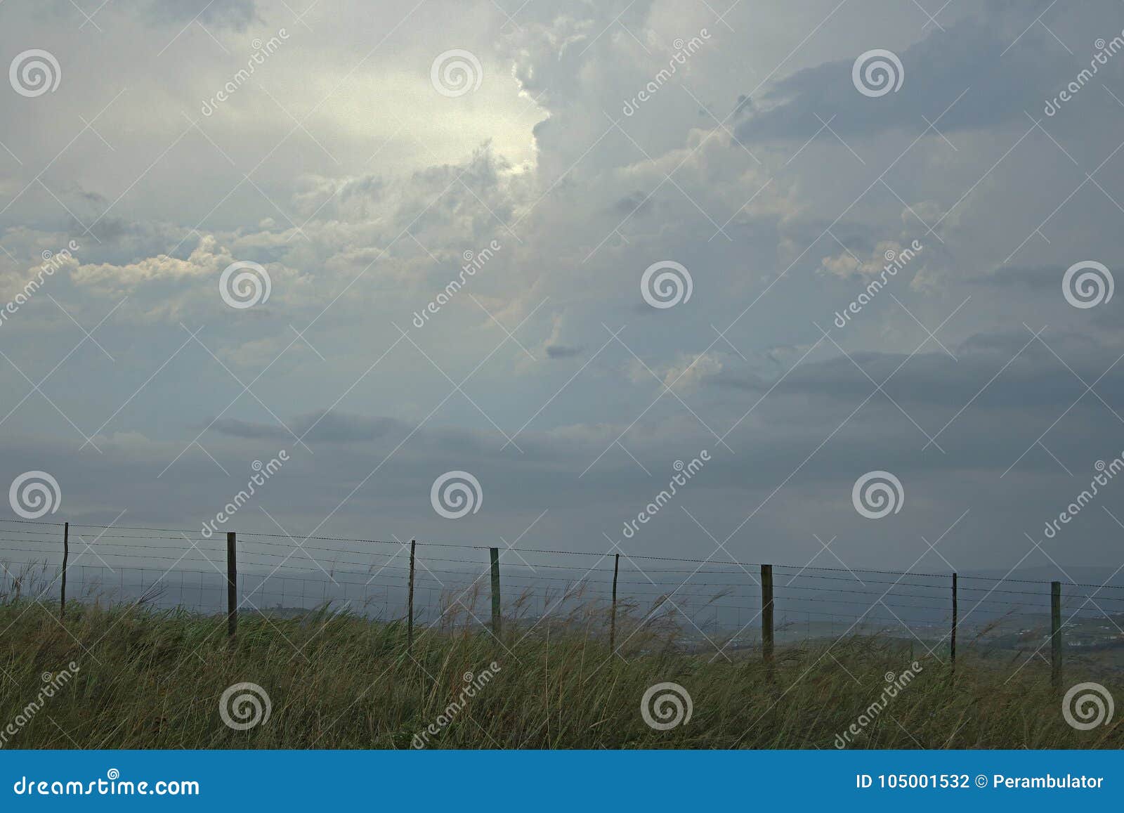 CLOUDY SKY BEHIND SCENE with GRASS and FENCE Stock Photo - Image of ...