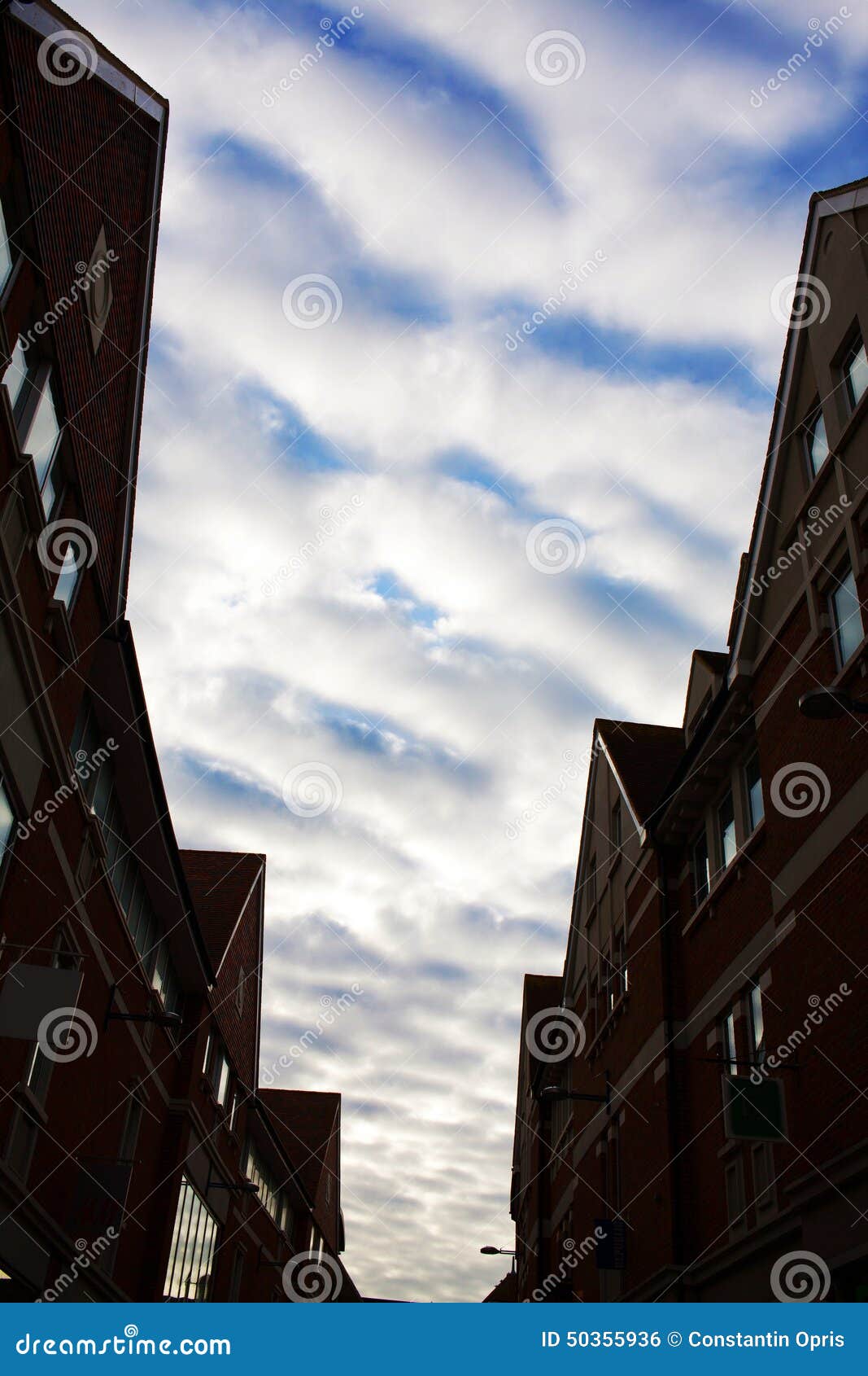 Cloudy Sky Framed by Buildings Stock Photo - Image of clouded, looking ...