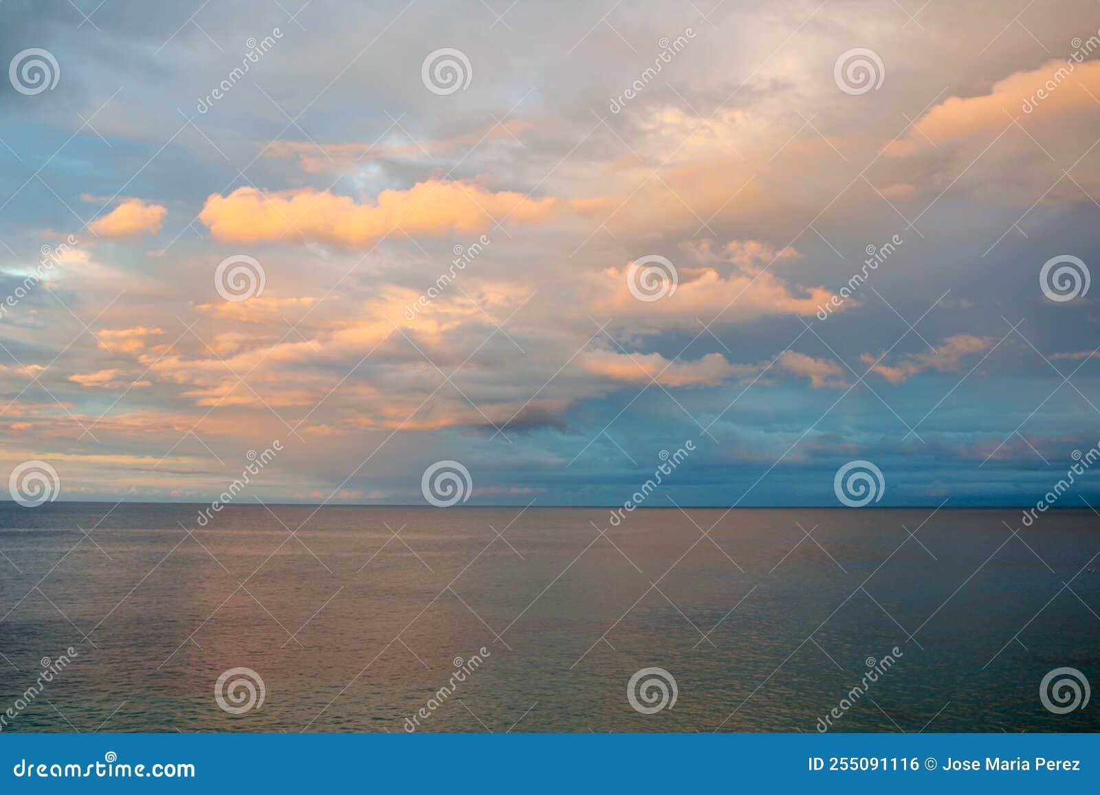 Cloudy sunset over the sea stock photo. Image of sunset - 255091116