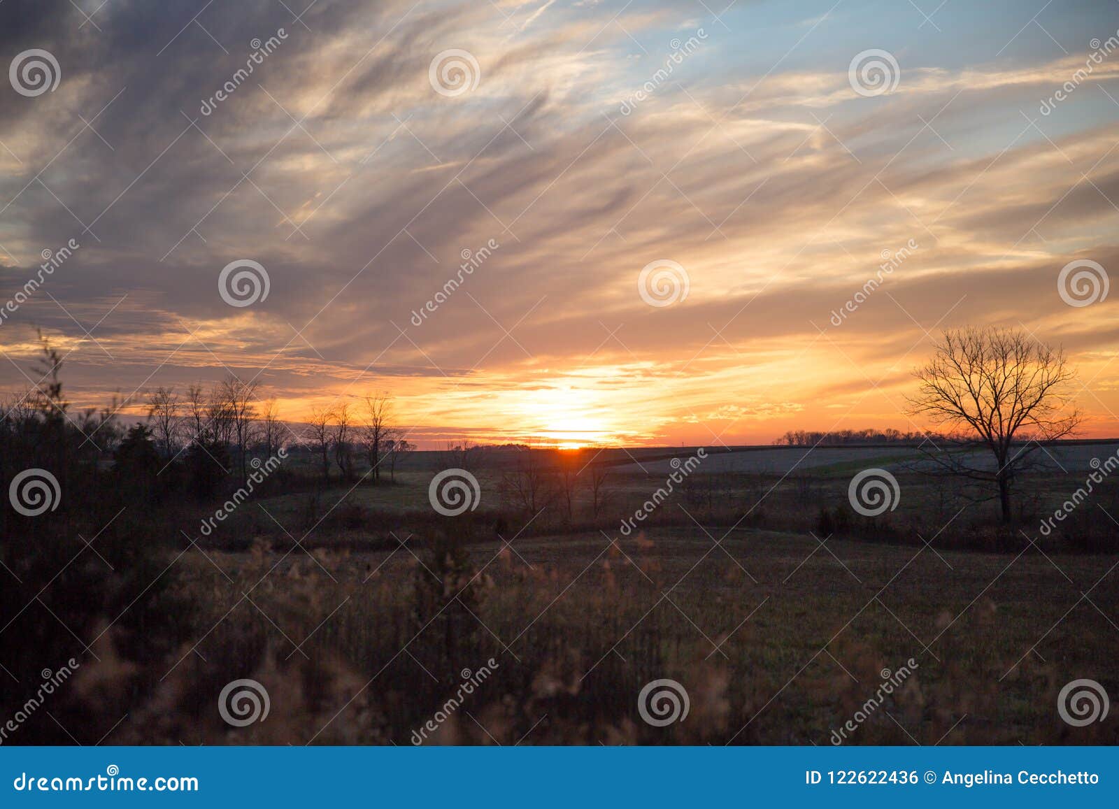 Cloudy Winter Sunset Over Wild Grass and Fields with Blue Sky in Stock Photo - Image of midlands ...