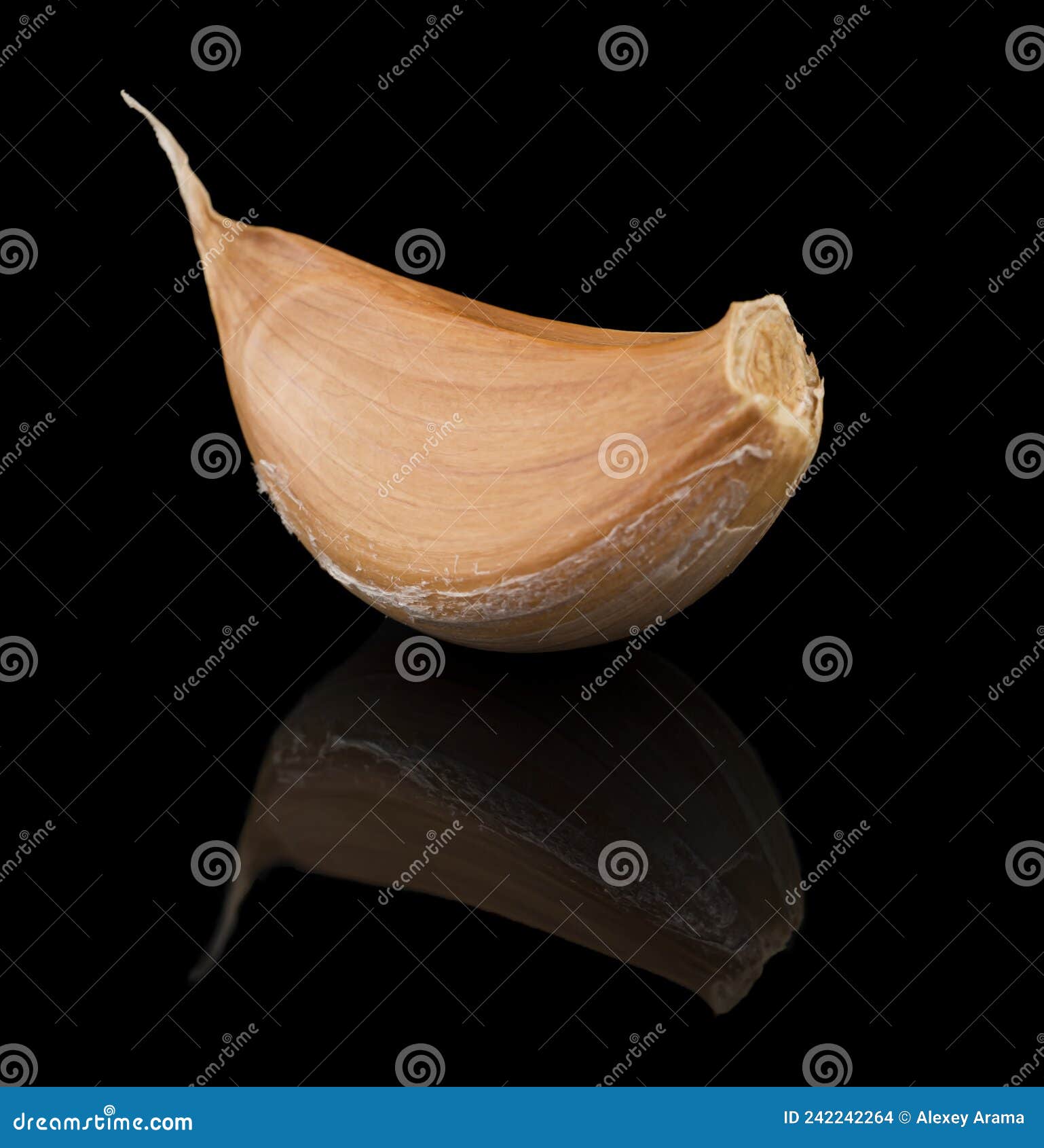 A Clove of Garlic in the Husk, on a Black Background, with Reflection ...