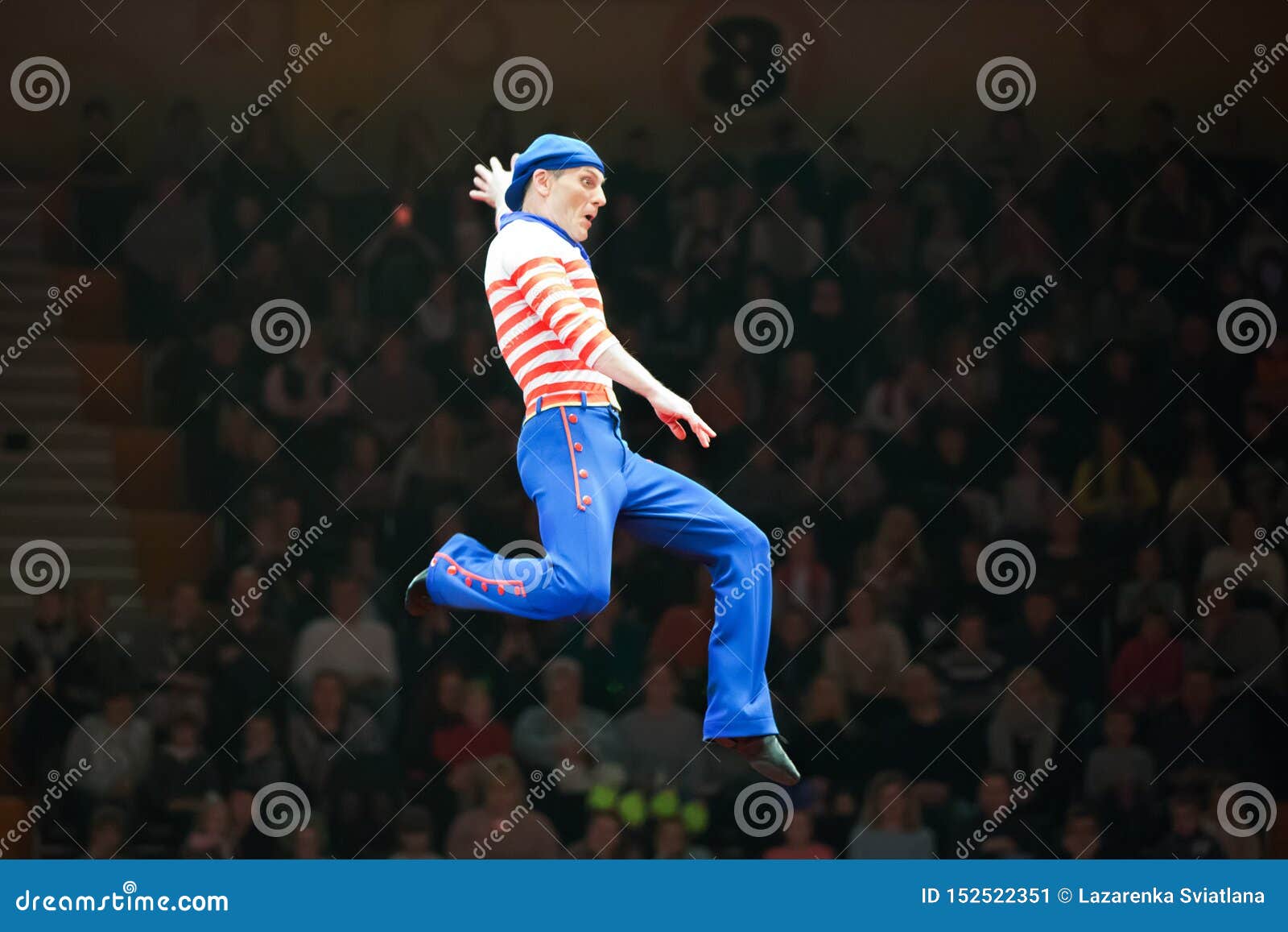 A Clown Acrobat Performs with a Number in Front of the Public ...