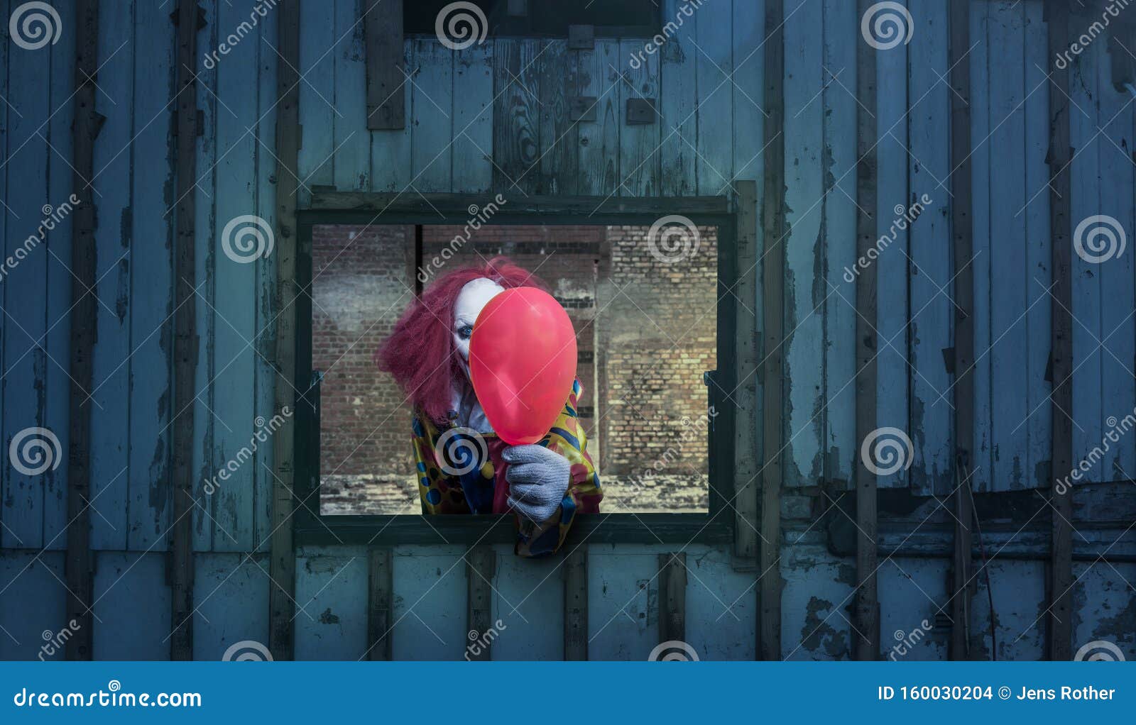 A Clown with a Balloon Looks Out of a Window Stock Photo - Image of ...