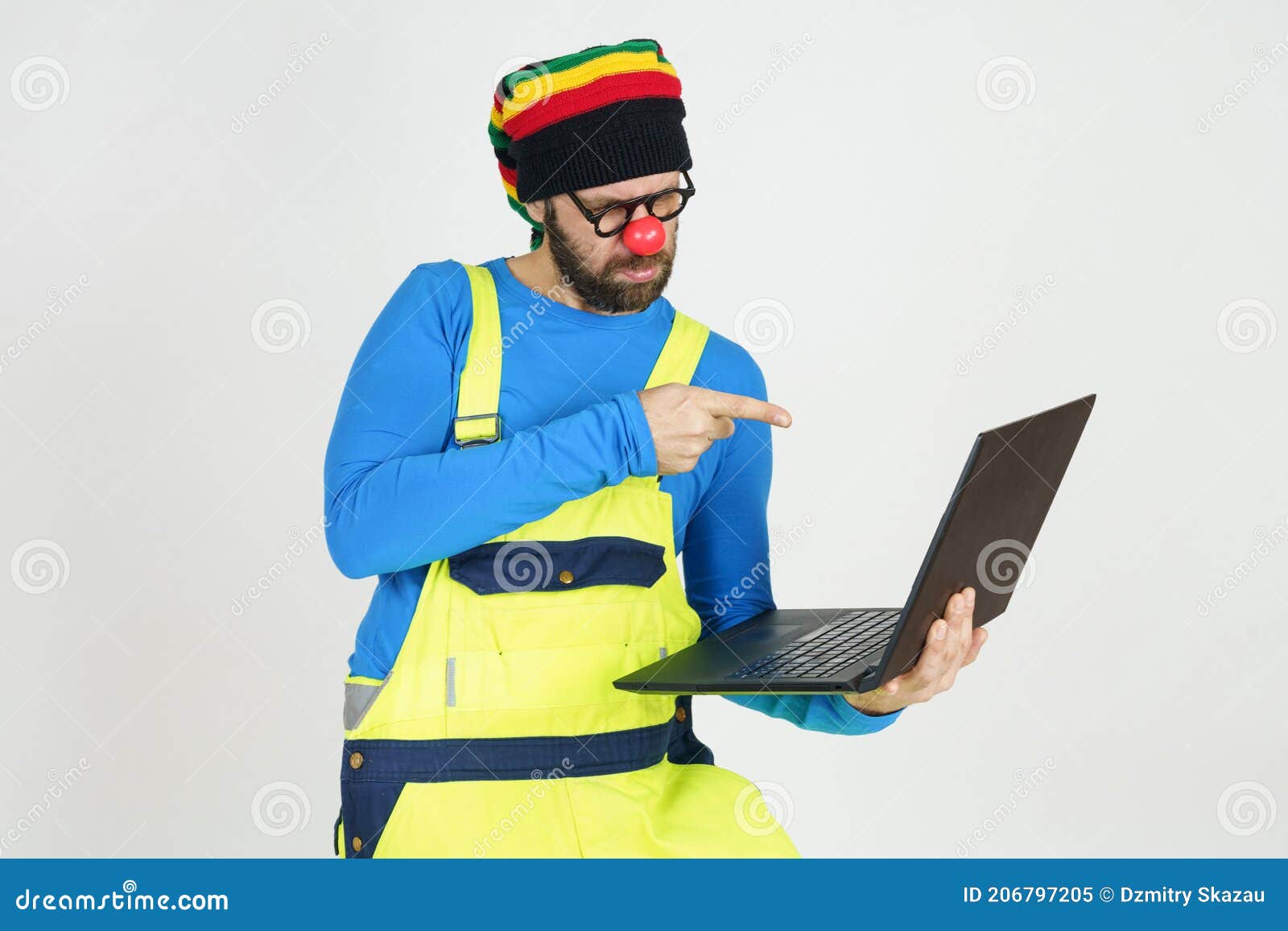 A Clown in a Bright Suit Holds a Computer in His Hands - Communicates ...