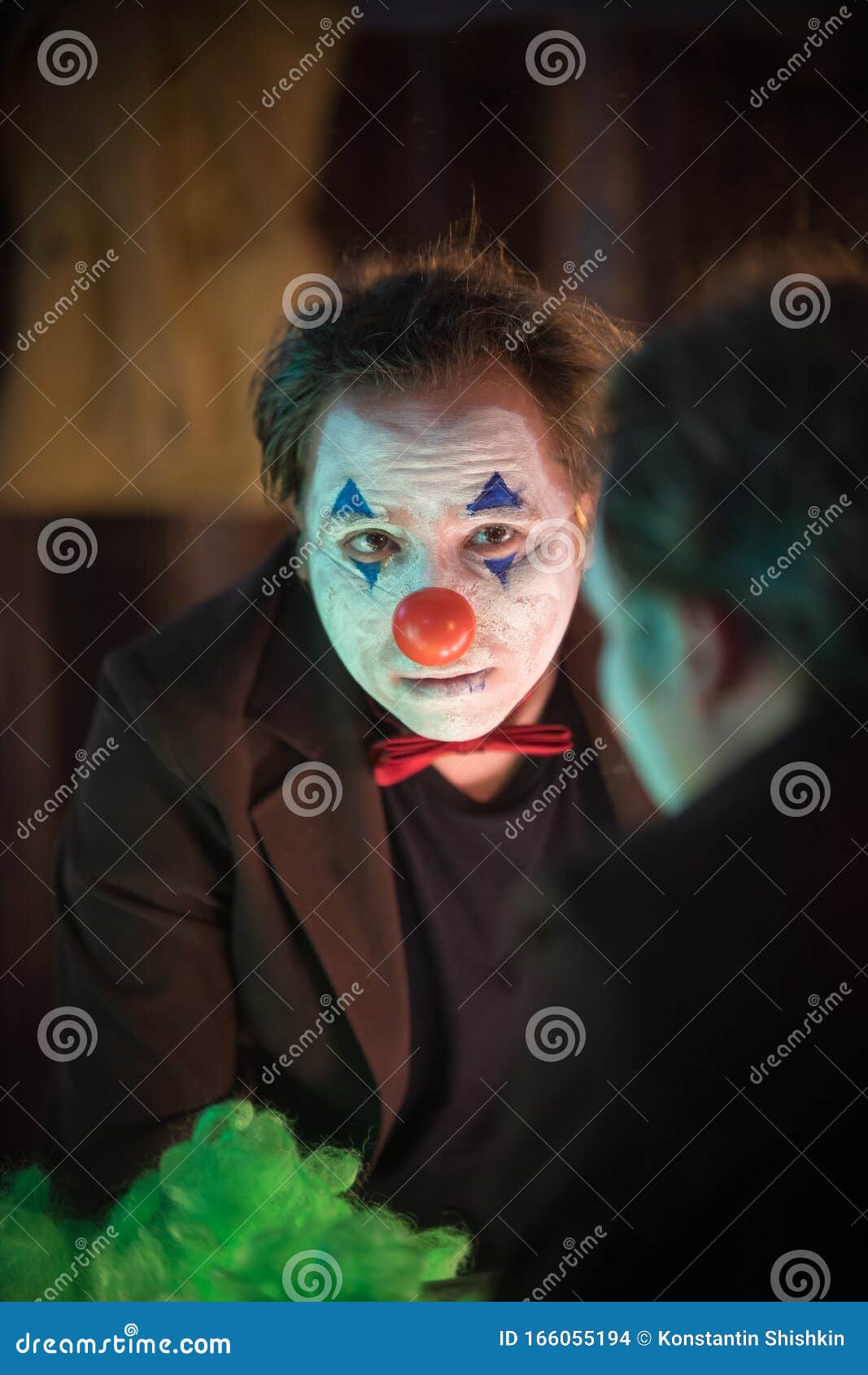 Clown Concept - a Man with Clown Painted Face Looking in the Mirror ...