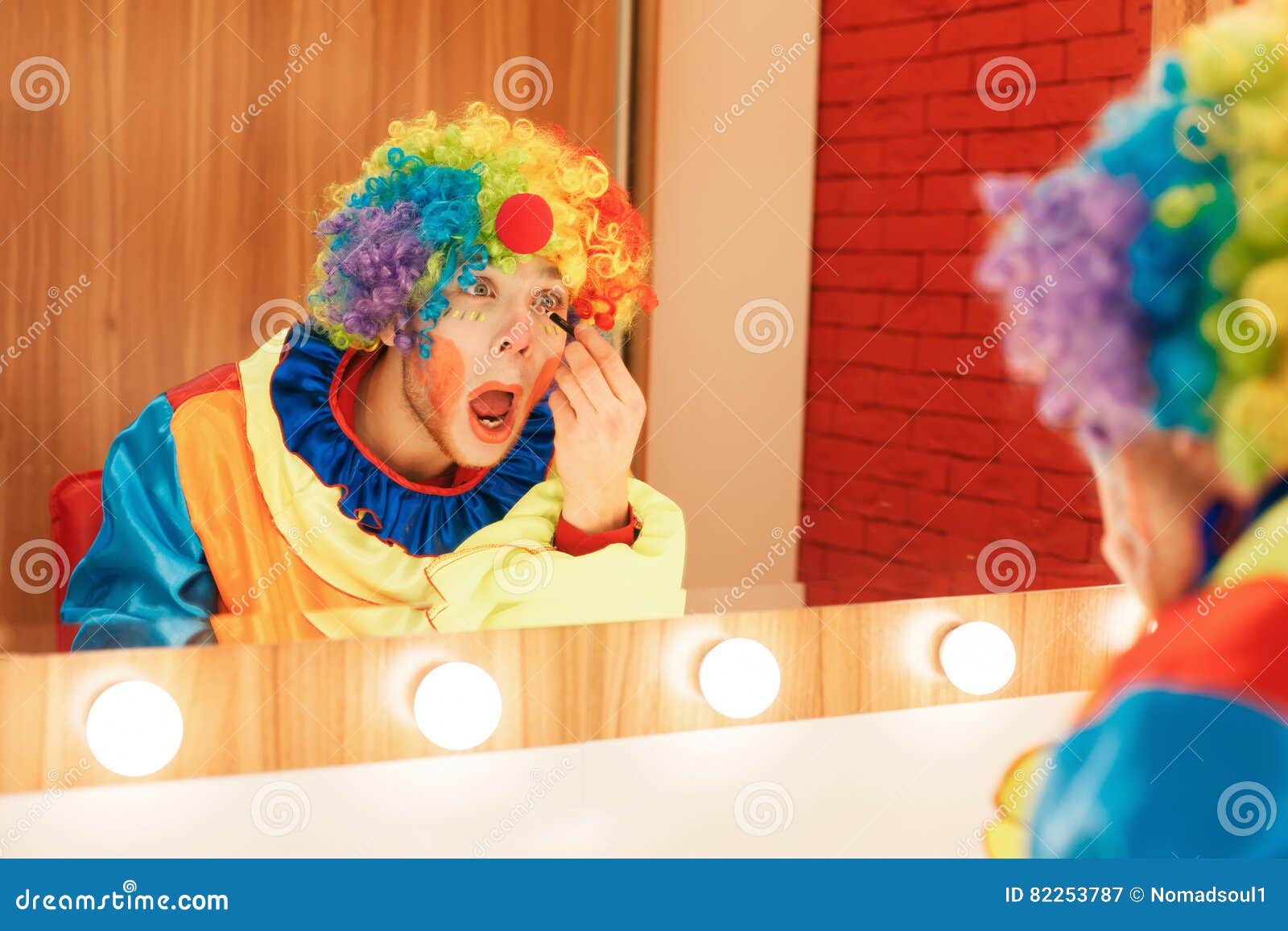 Clown Does a Make-up in Front of the Mirror. Stock Image - Image of ...