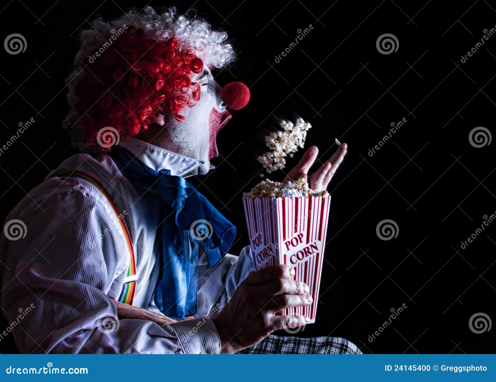 Clown eating popcorn stock photo. Image of expression - 24145400