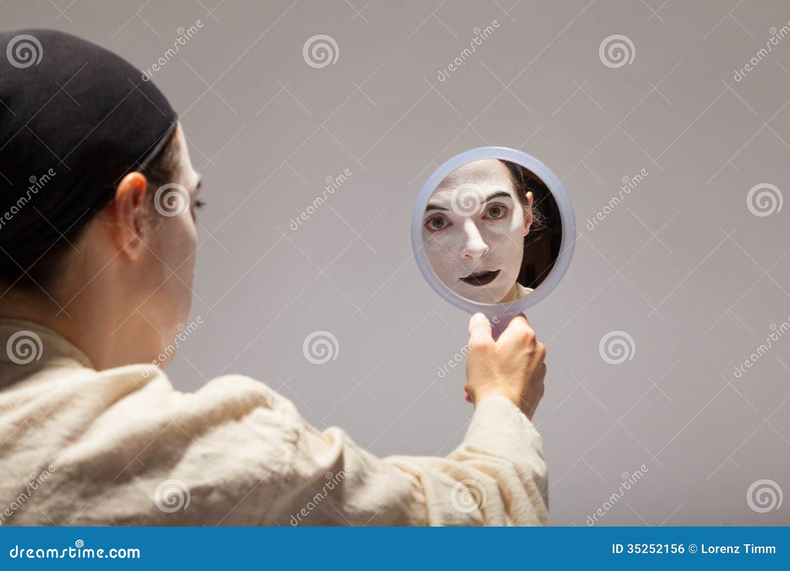 The Clown is Sitting on the Ground with a Mirror in His Hand Stock ...