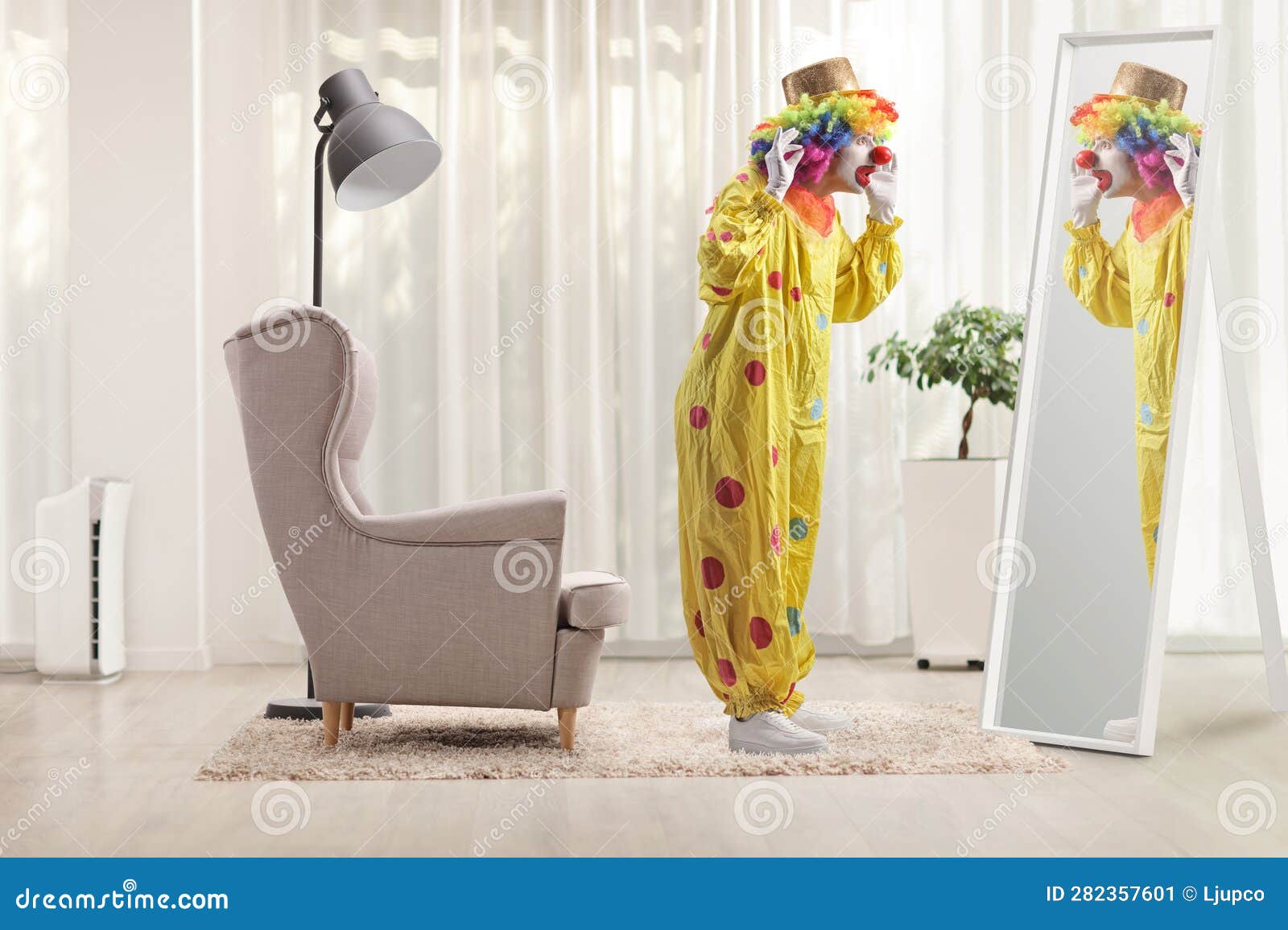 Clown in a Yellow Costume Standing in Front of a Mirror at Home Stock ...