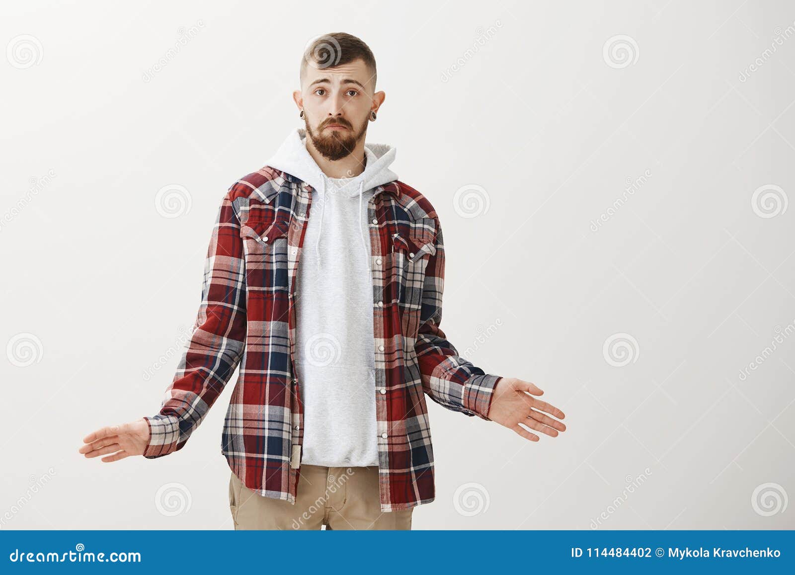 Clueless Handsome Male Student with Beard and Stylish Haircut Spreading ... Clueless Handsome Male Student with Beard and Stylish Haircut Spreading ...