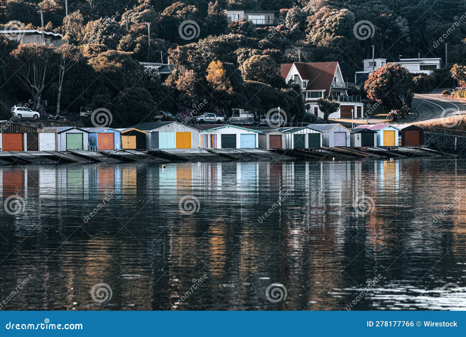 Cluster of Brightly-colored Homes Reflected in the Lake Stock Photo ...