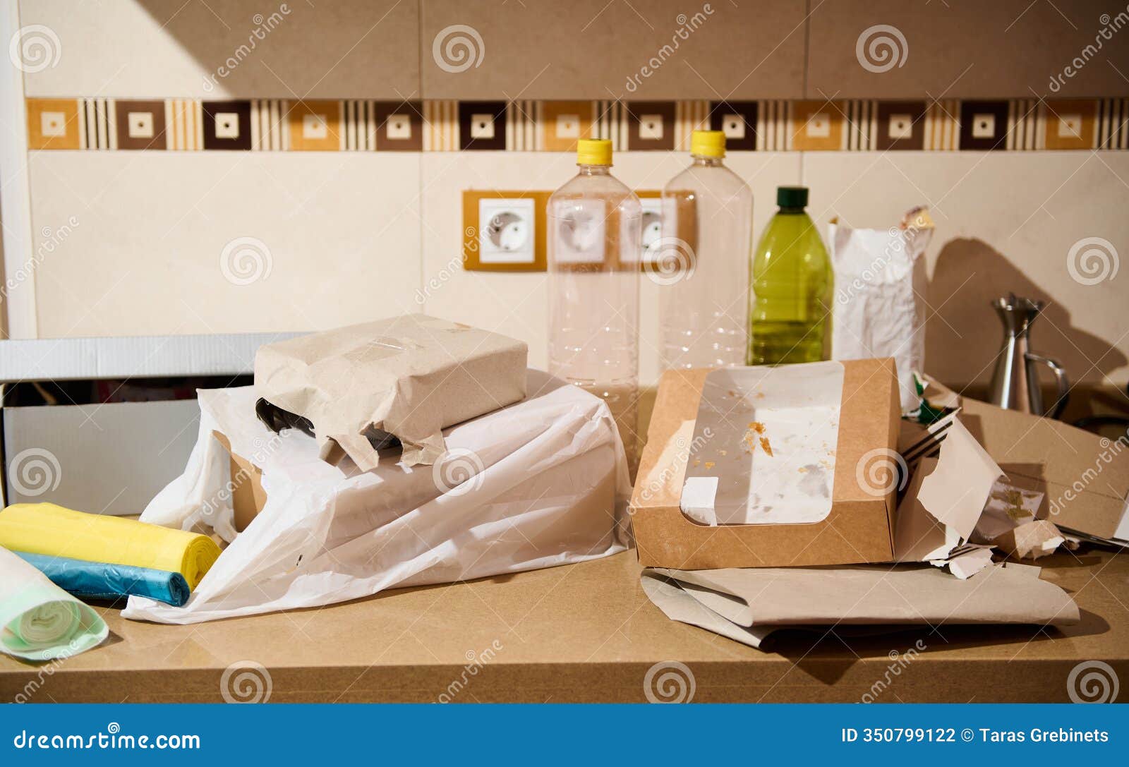Cluttered Kitchen Counter with Disposable Packaging and Bottles in ...