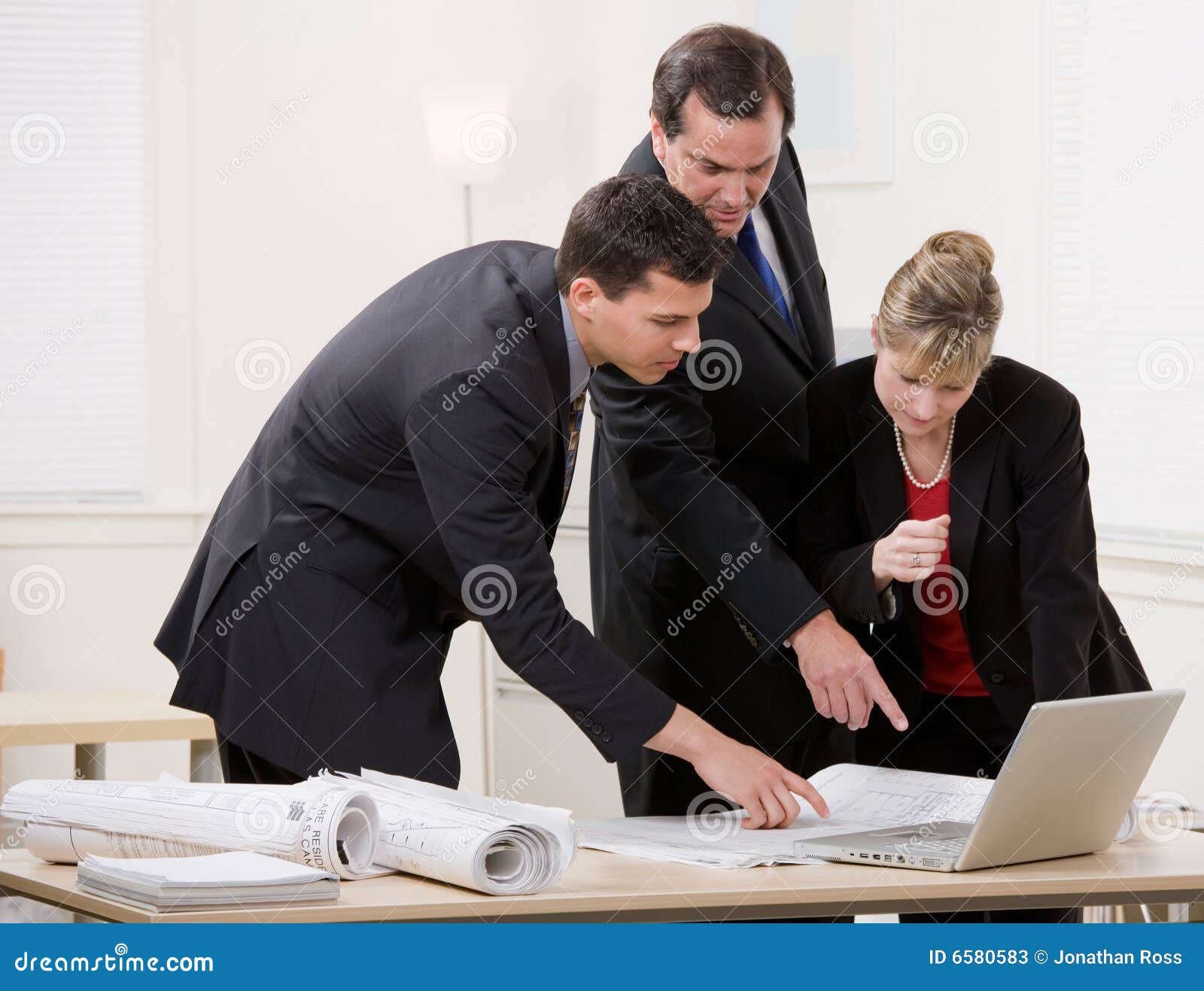 Co-workers Collaborating on Blueprints Stock Image - Image of ...