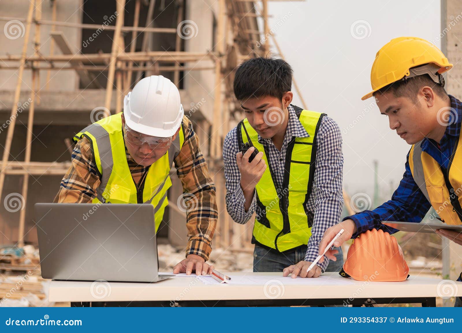 Co-workers Discussing Architecture Projects at Construction Site at ...