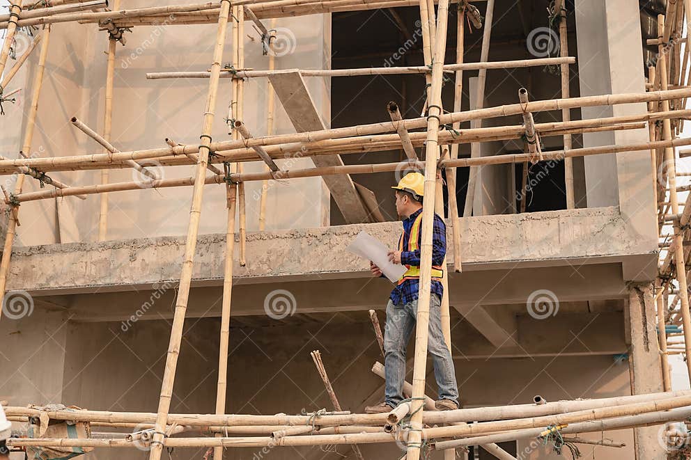 Co-workers Discussing Architecture Projects at Construction Site at ...