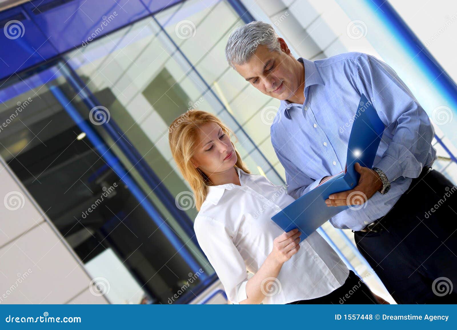 Co-Workers Reviewing Documents Stock Photo - Image of assistants ...