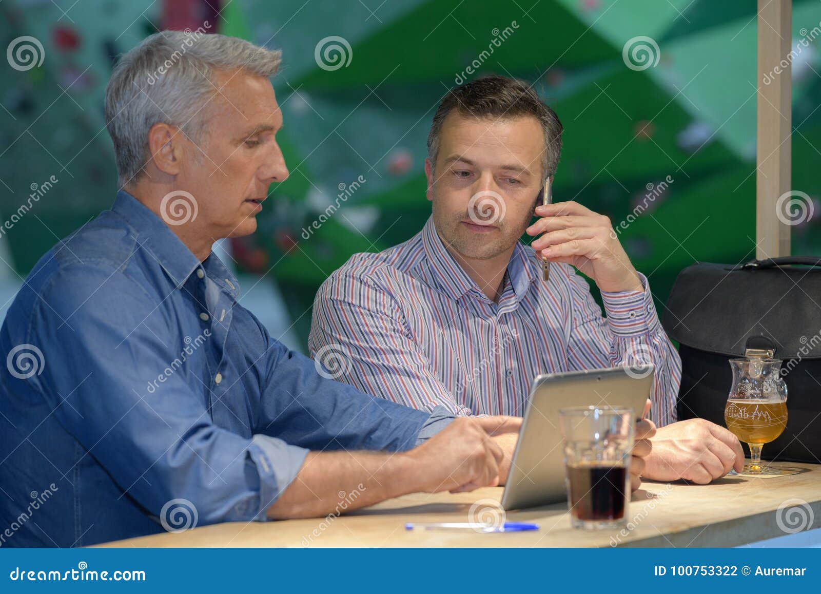 Co-workers Working while Drinking Beer Stock Photo - Image of ...