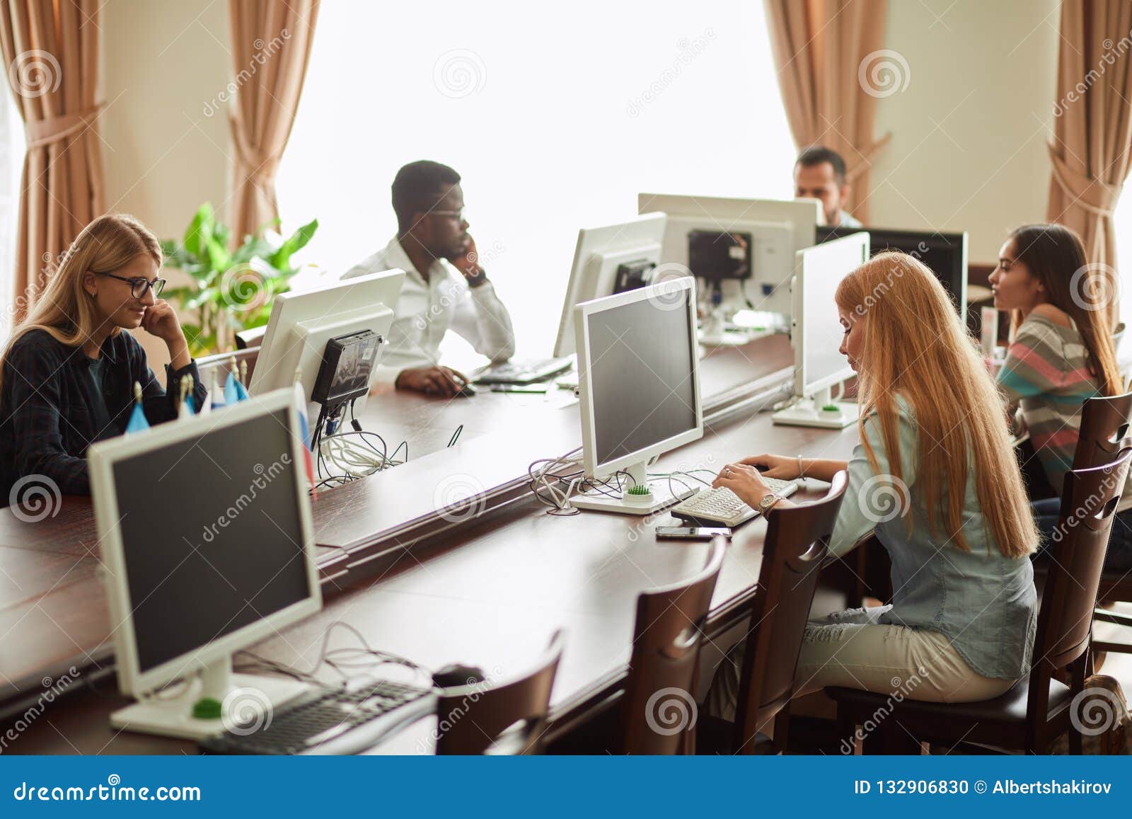 Caucasian Woman Using Personal Computer To Browse the Net in Office ...