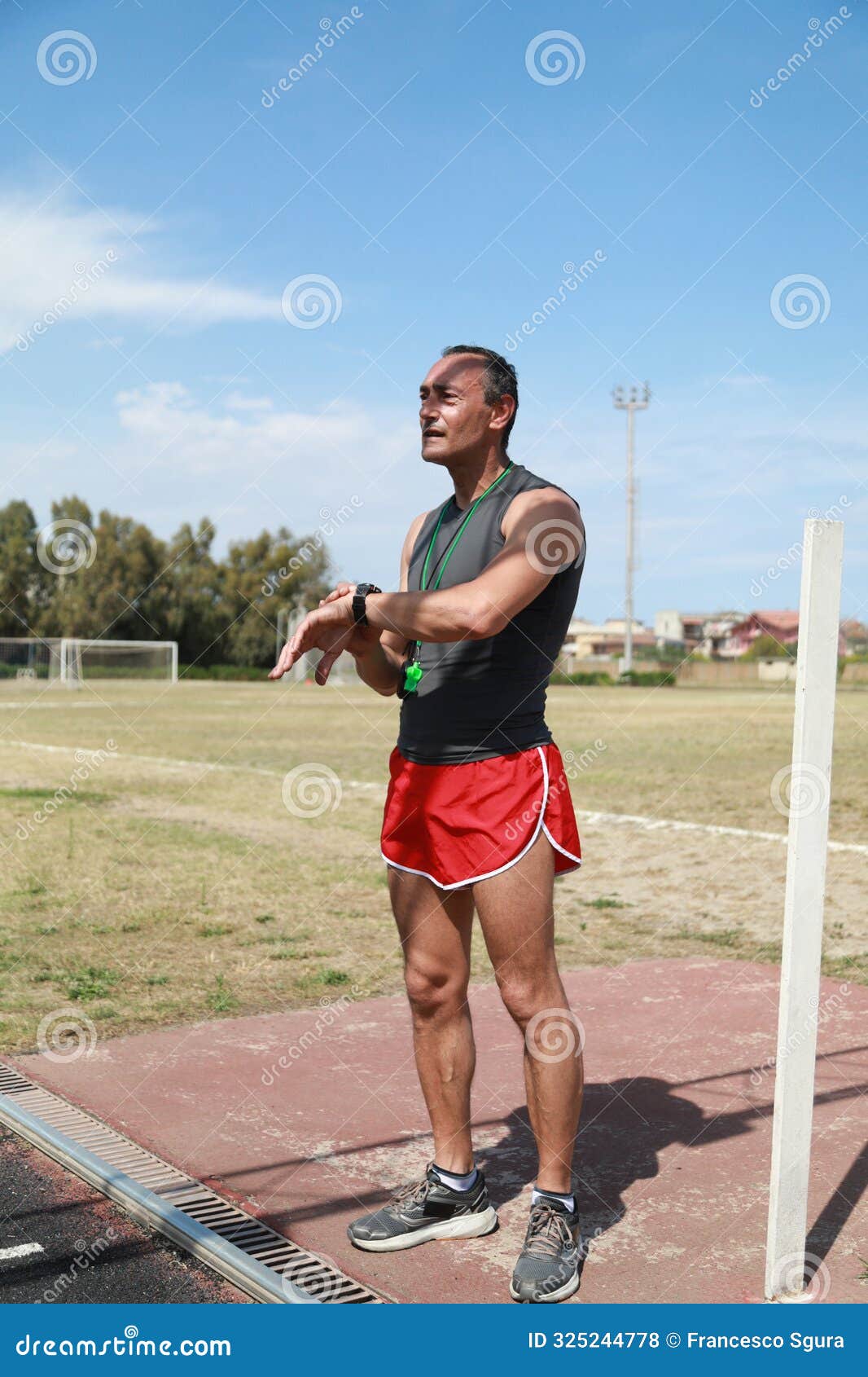 Coach Checking Time on His Smartwatch Stock Photo - Image of sportswear ...