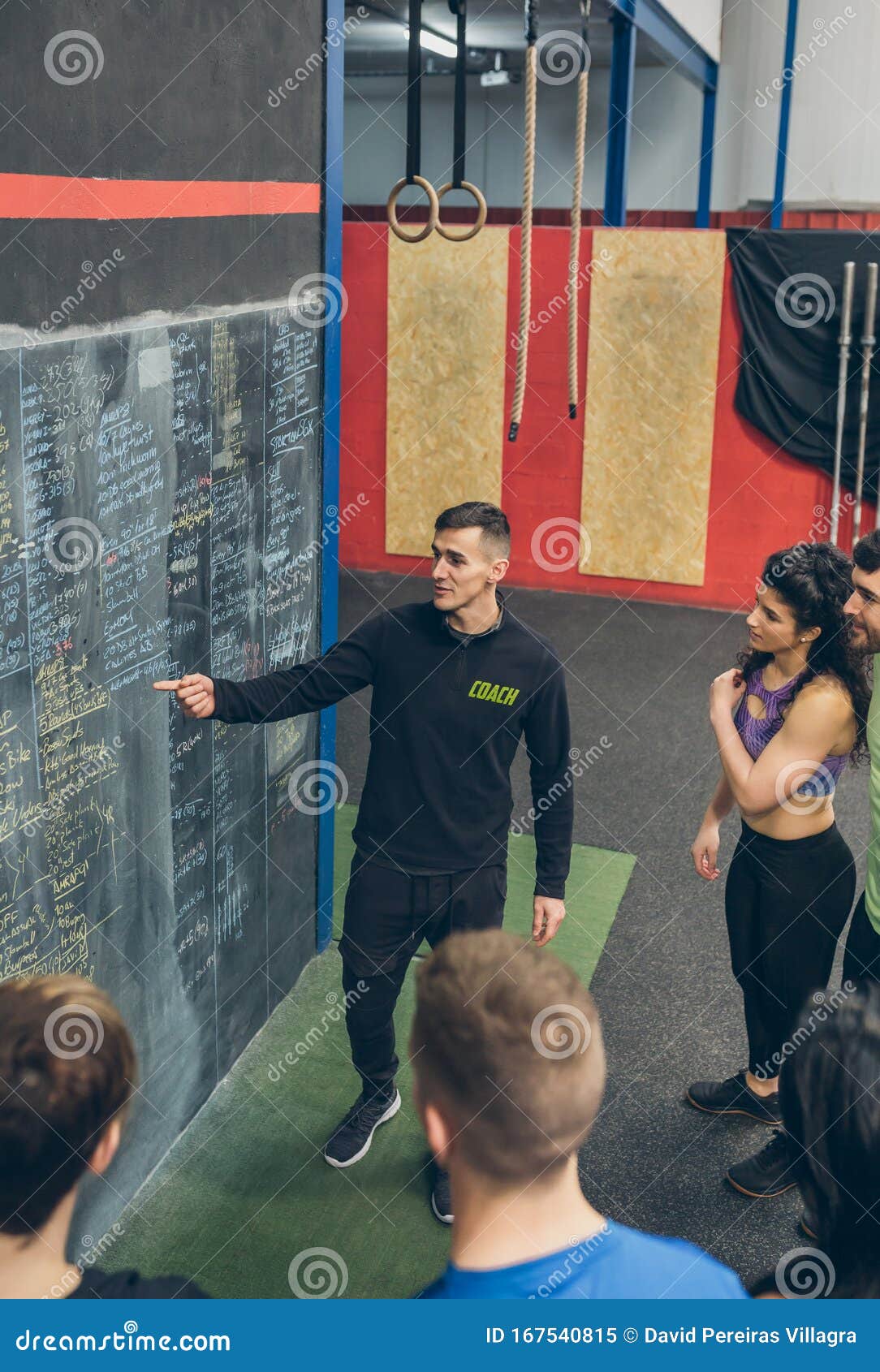 Coach Explaining To Athletes in the Gym Stock Image - Image of ...
