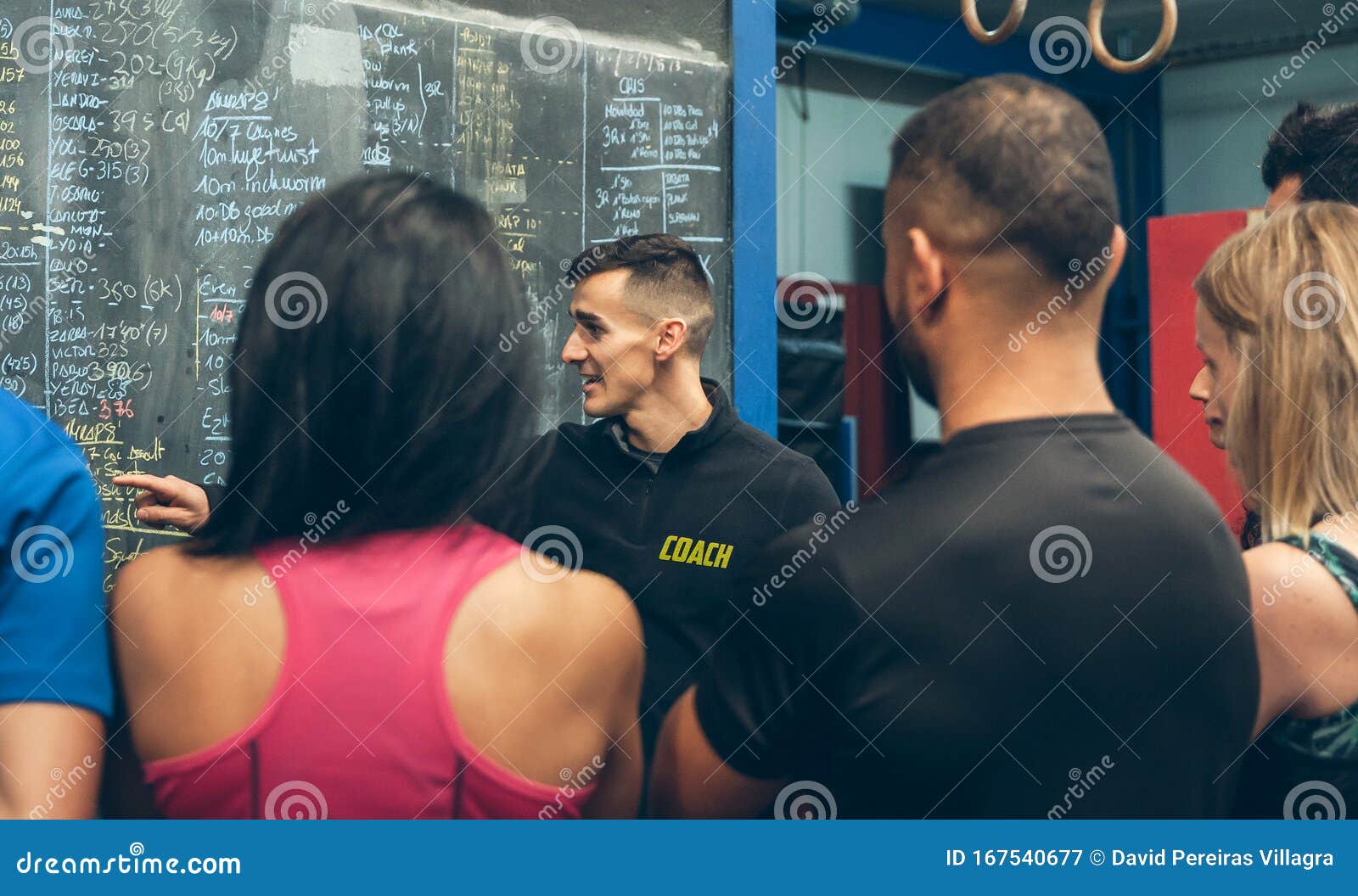 Coach Explaining To Athletes in the Gym Stock Image - Image of ...
