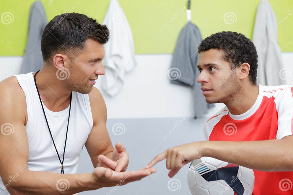 Coach and Player Talking in Changing Room Stock Photo - Image of club ...