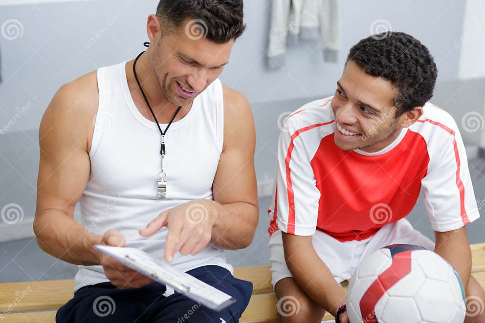 Coach and Player Talking in Changing Room Stock Photo - Image of ...