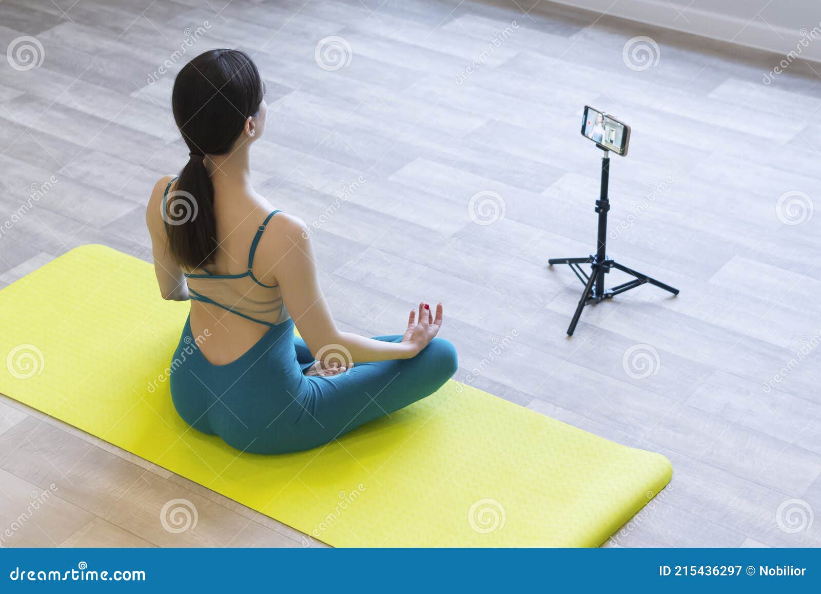 Coach Sitting on a Floor and Recording a Video Tutorial for Her ...