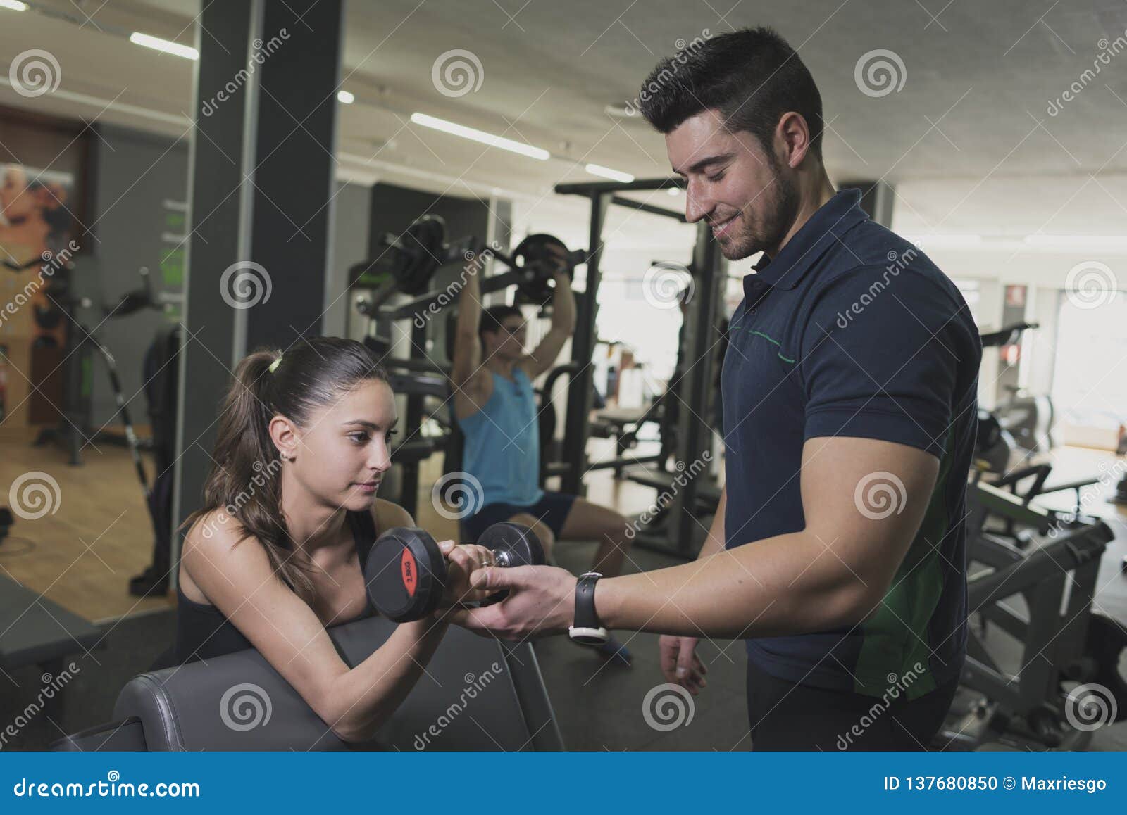 Coach Training Young Woman Lifting Weights at Gym Stock Photo - Image ...