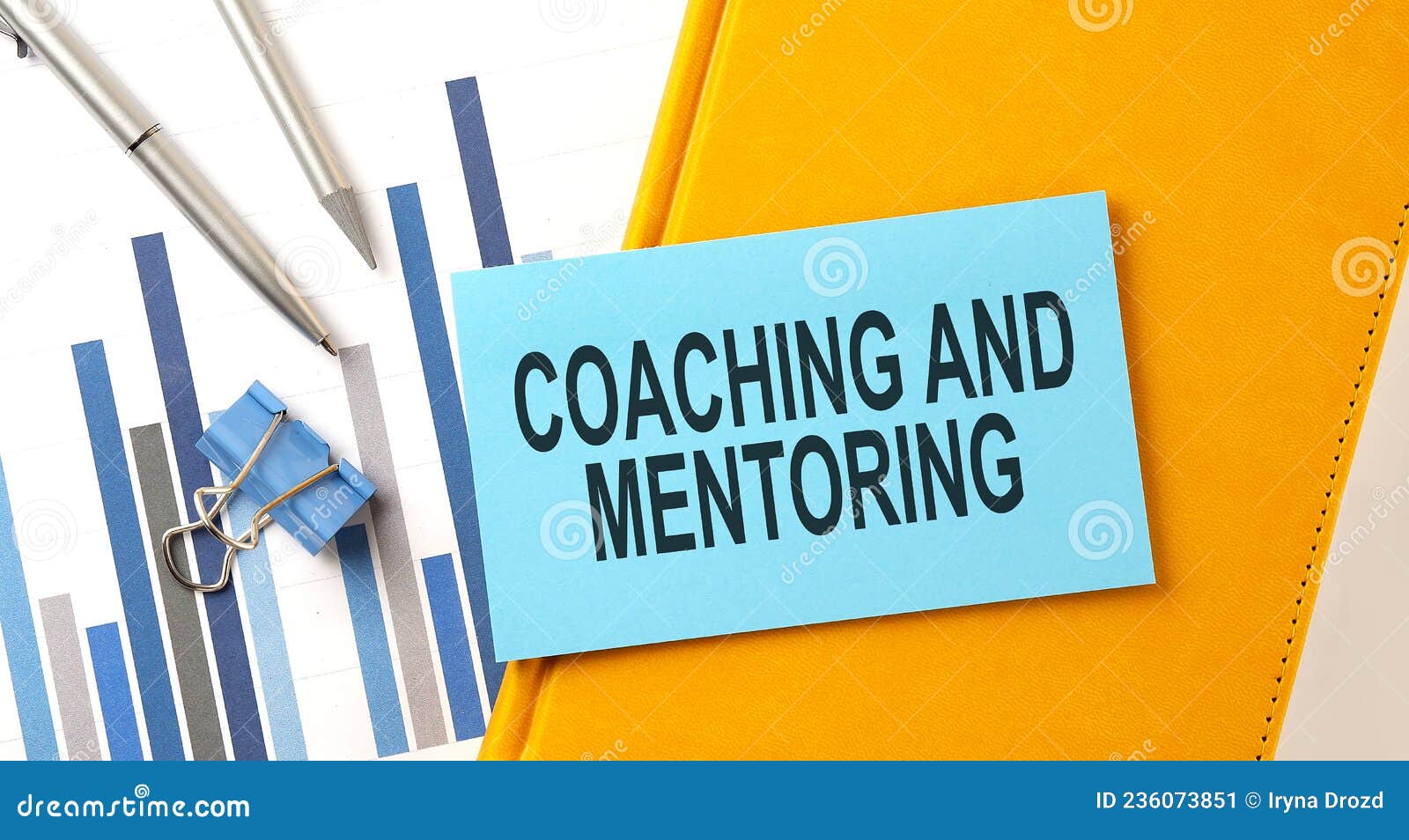 COACHING and MENTORING Message on Blue Sticker on Notebook with Chart ...
