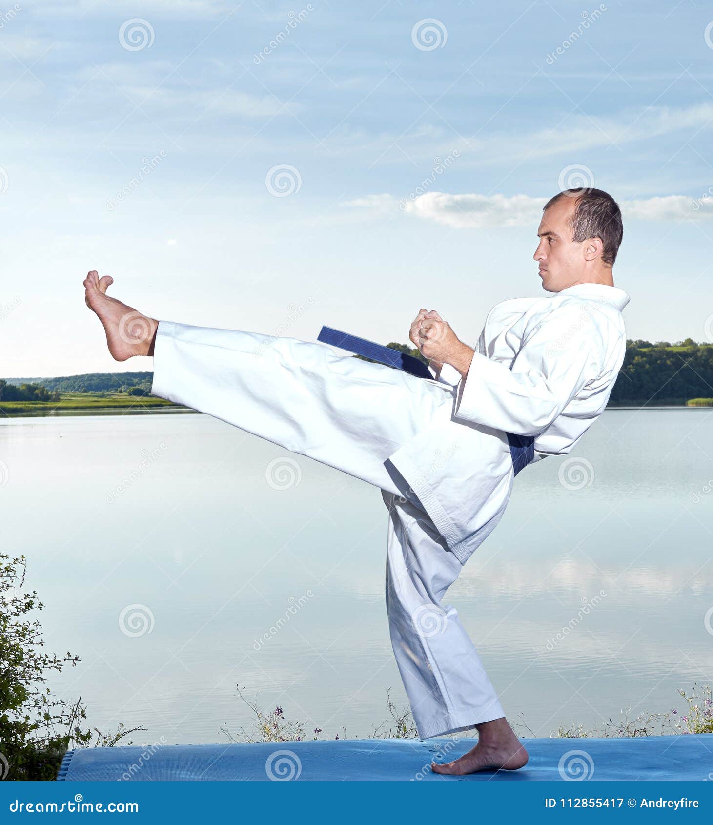 On Coast of Lake Athlete Beats a Kick Leg Forward Stock Image - Image ...