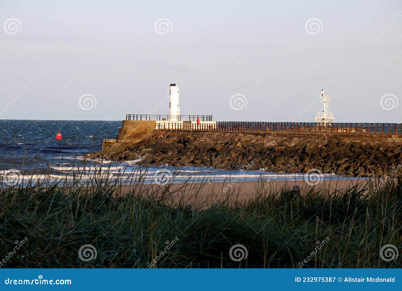 Coastal Beach with Jetty and Harbour Light Stock Image - Image of ...