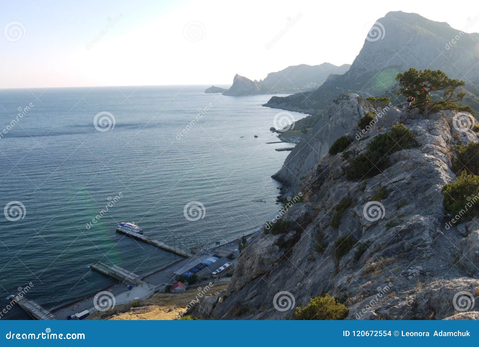 Coastal Steep Cliffs on the Background of High Mountains Covered with ...