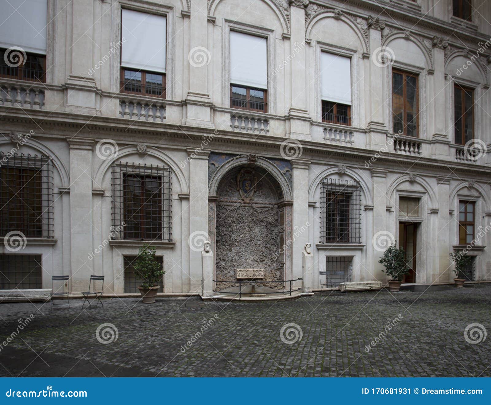 Cobbled Courtyard and a Fountain in the Wall Stock Image - Image of ...