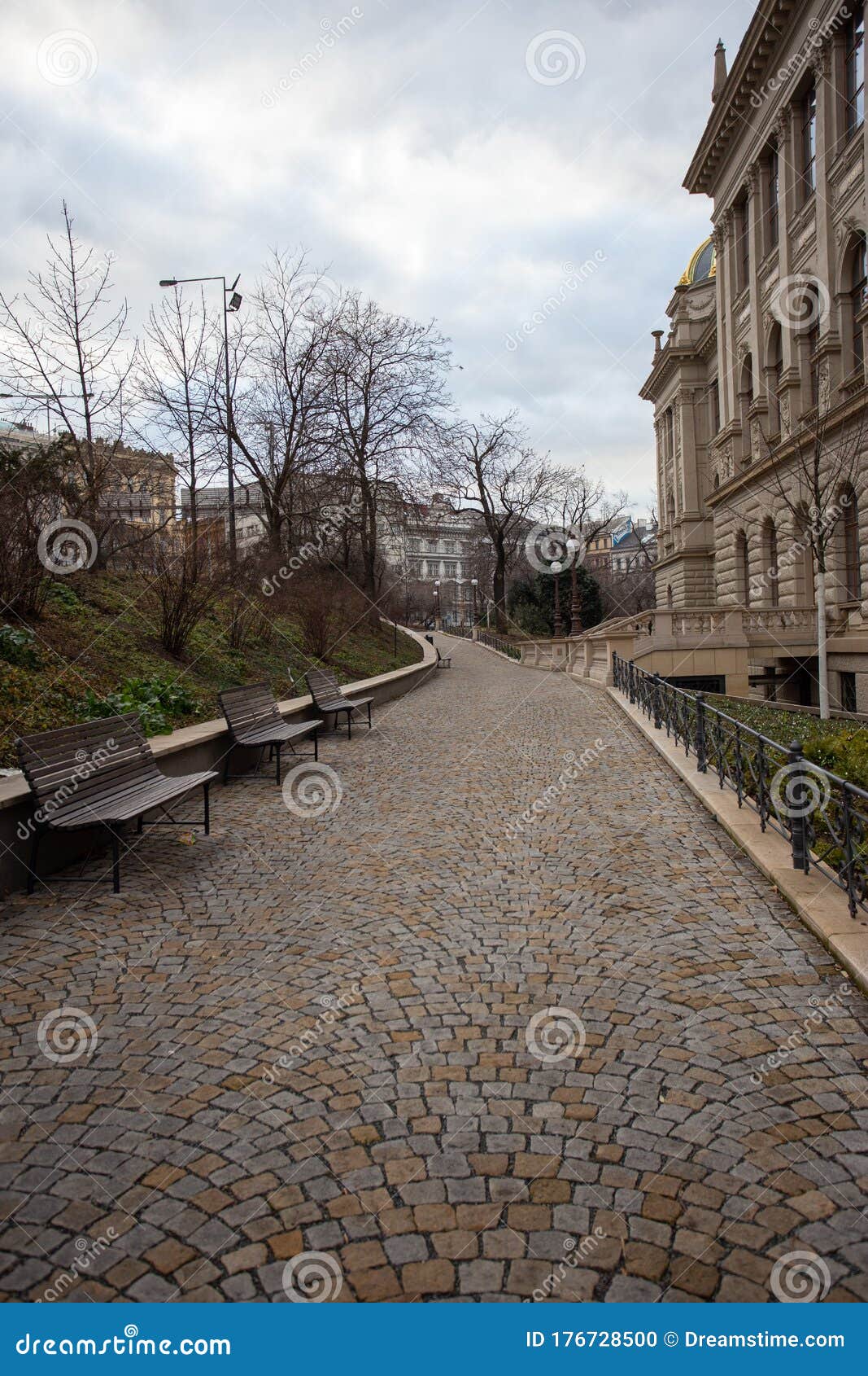 Cobbled Pathway and Two Benches on One Side of it Stock Photo - Image ...