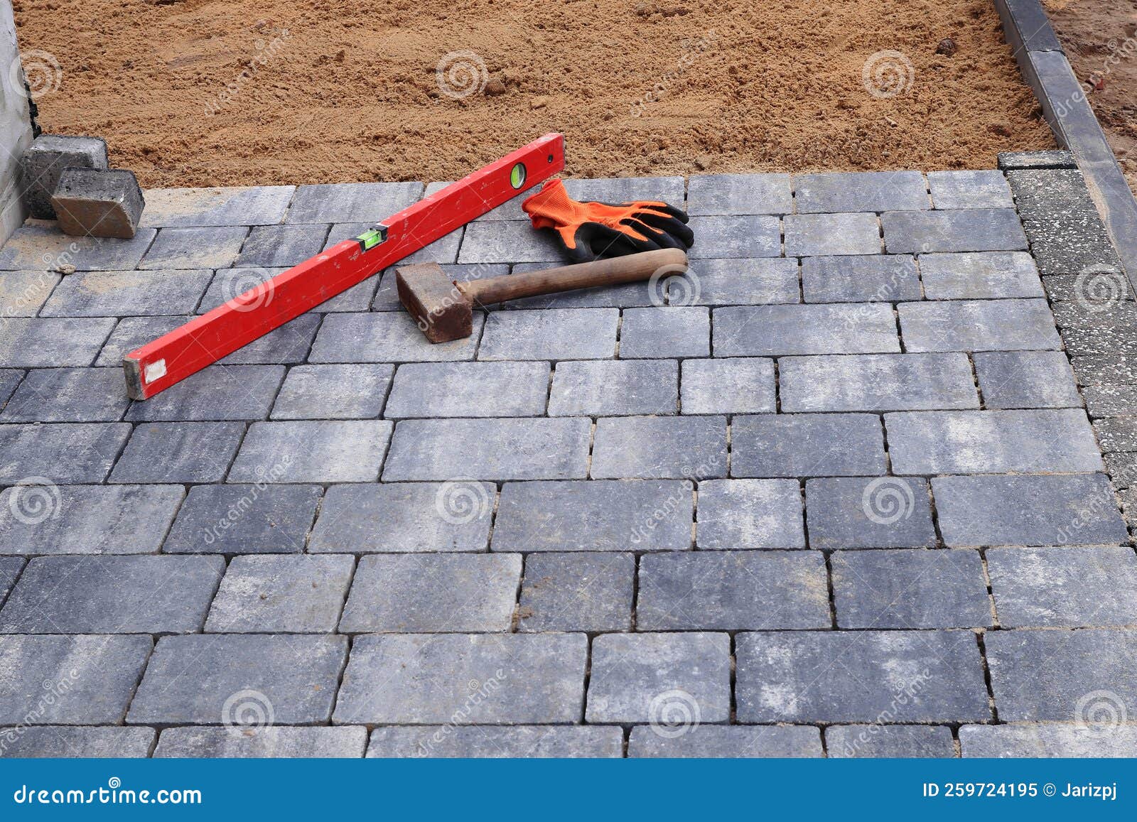 Laying paving stones stock image. Image of kostki, home - 259724195