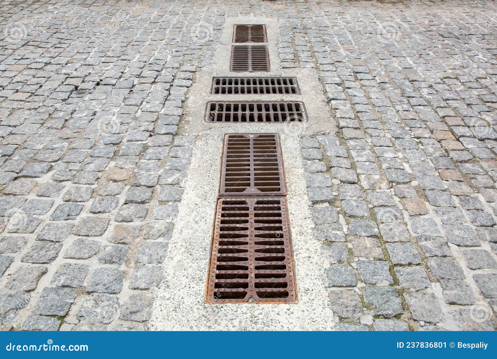 Cobblestone Road of Granite Stone with Drainage Grates. Stock Image ...