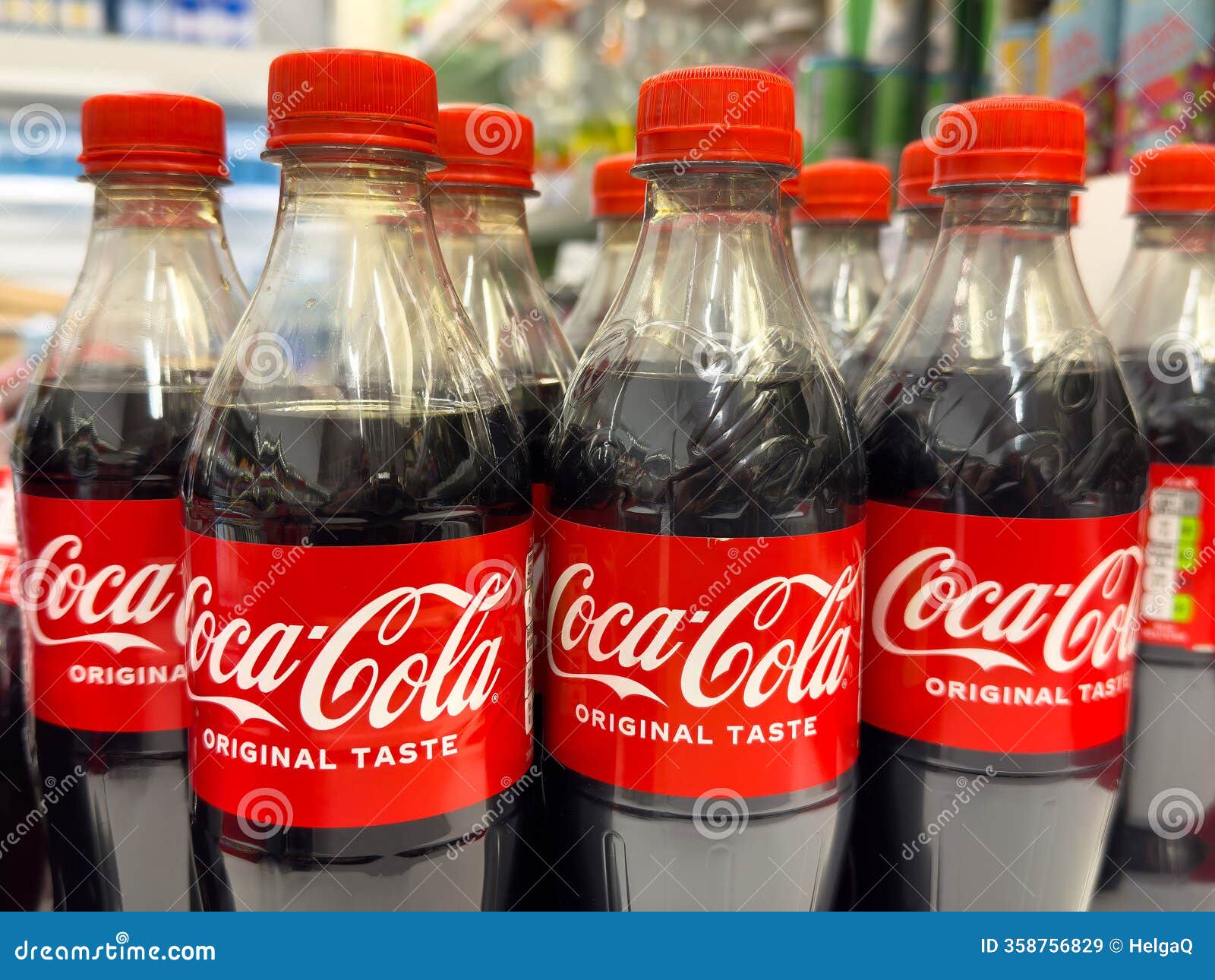Coca-cola Bottles on Store Shelf with Red Caps and Labels Editorial ...