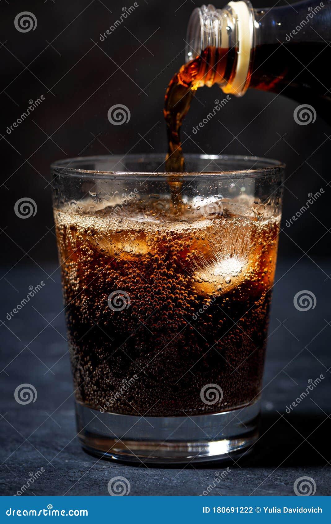 Coca Cola is Pouring into a Glass from a Bottle, Closeup Vertical Stock ...