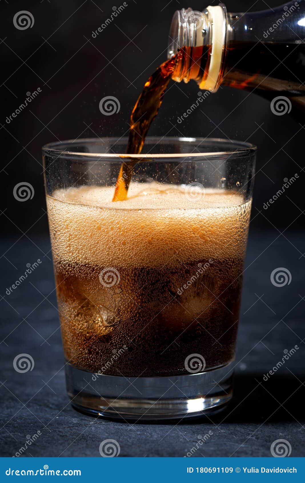 Coca Cola is Pouring into a Glass from a Bottle, Vertical Stock Image ...