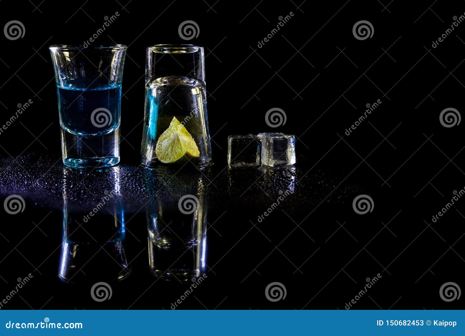 Cocktail Blue Shots with Salt and Lime, Ice Cubes on Black Background ...