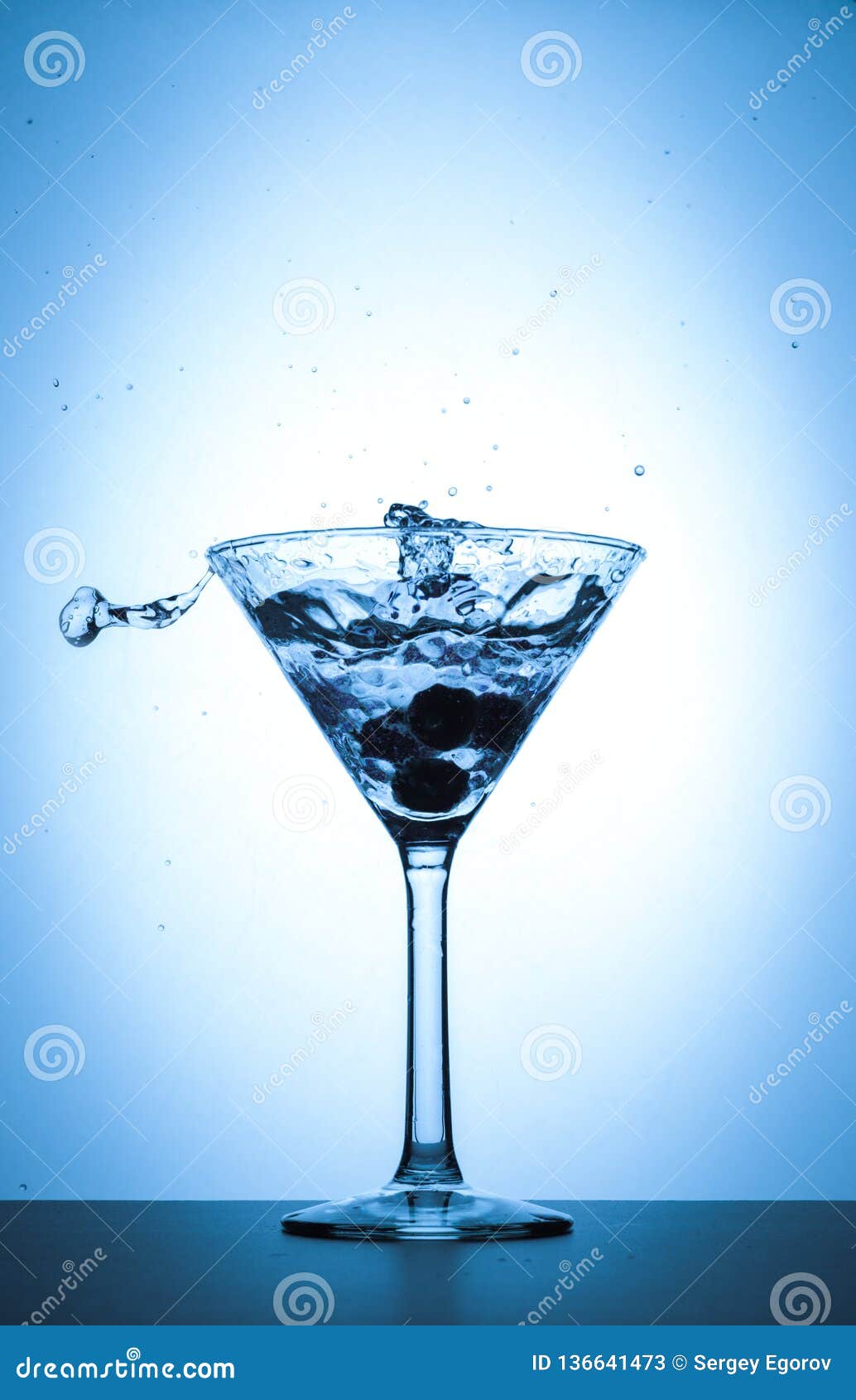 Cocktail Martini Glass Splash on White and Blue Gradient Background ...