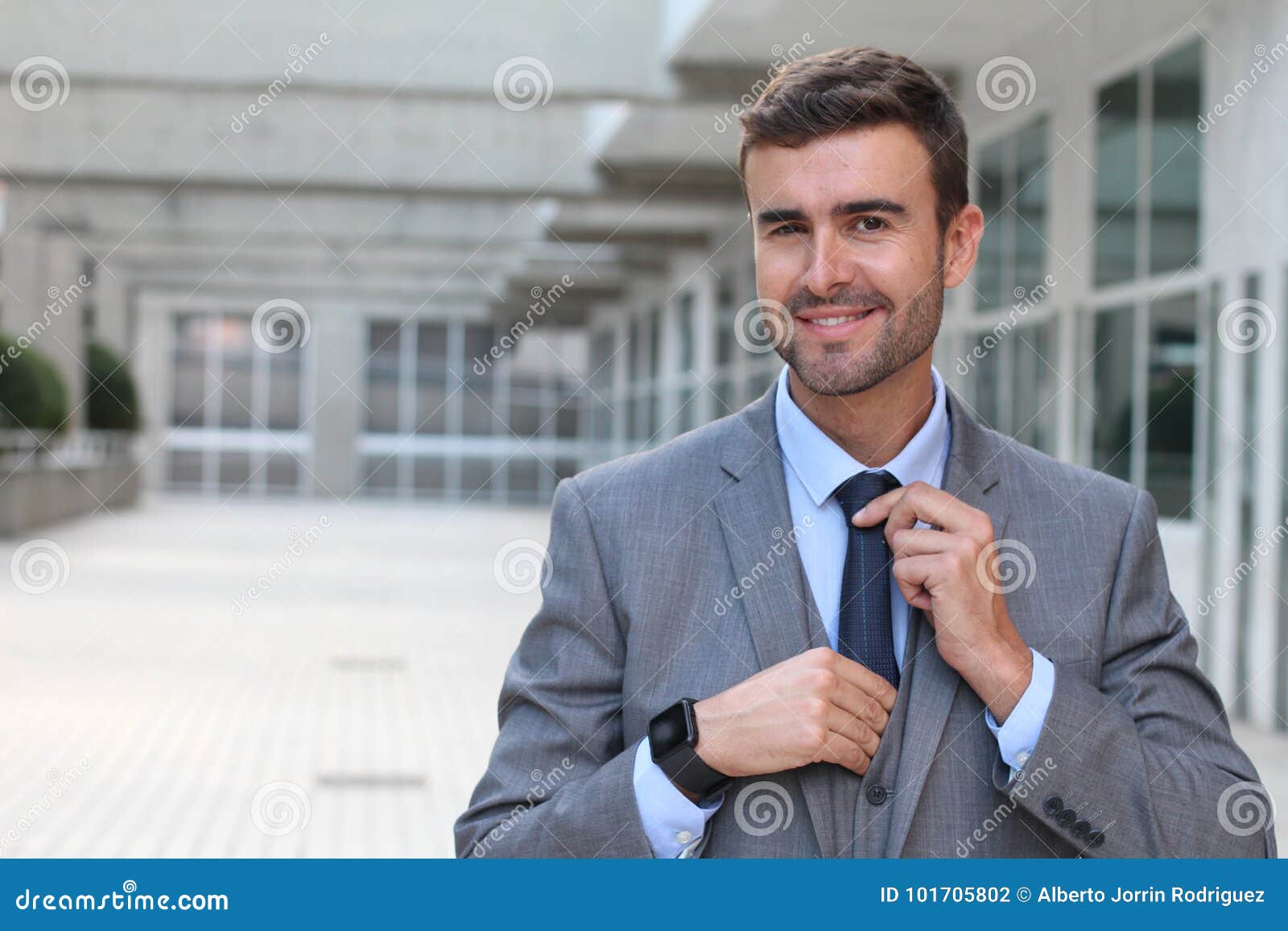 Cocky Businessman Adjusting His Tie with Copy Space Stock Photo - Image ...
