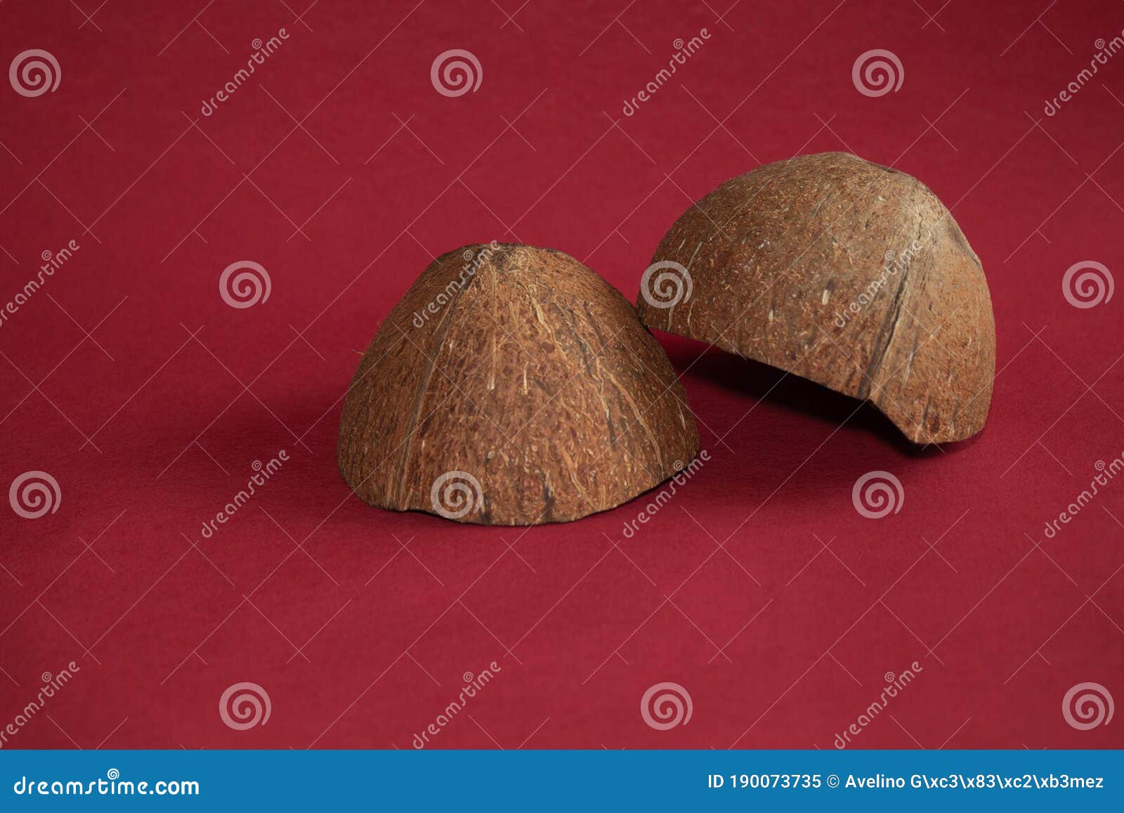 Coconut Fruit Shells Cut in Half and Insulated on a Red Background ...