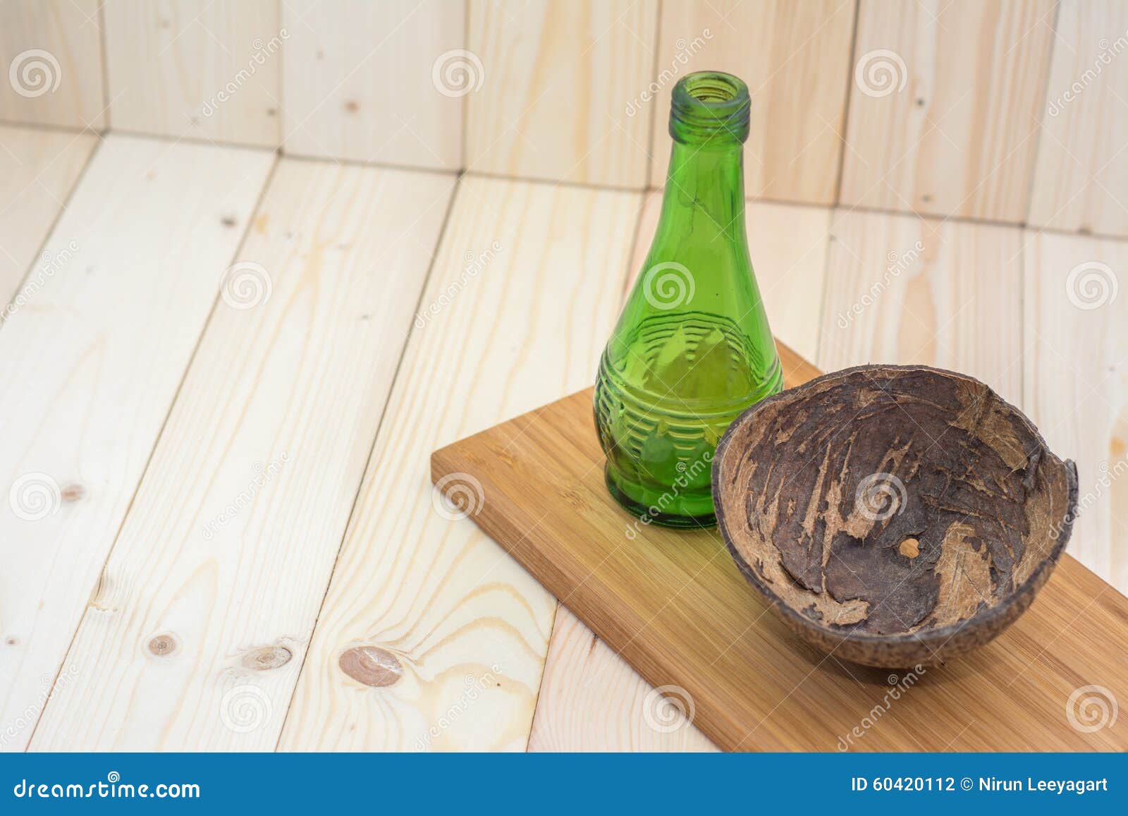 Coconut Shell with Green Glass Bottles on Splat. Stock Photo - Image of ...
