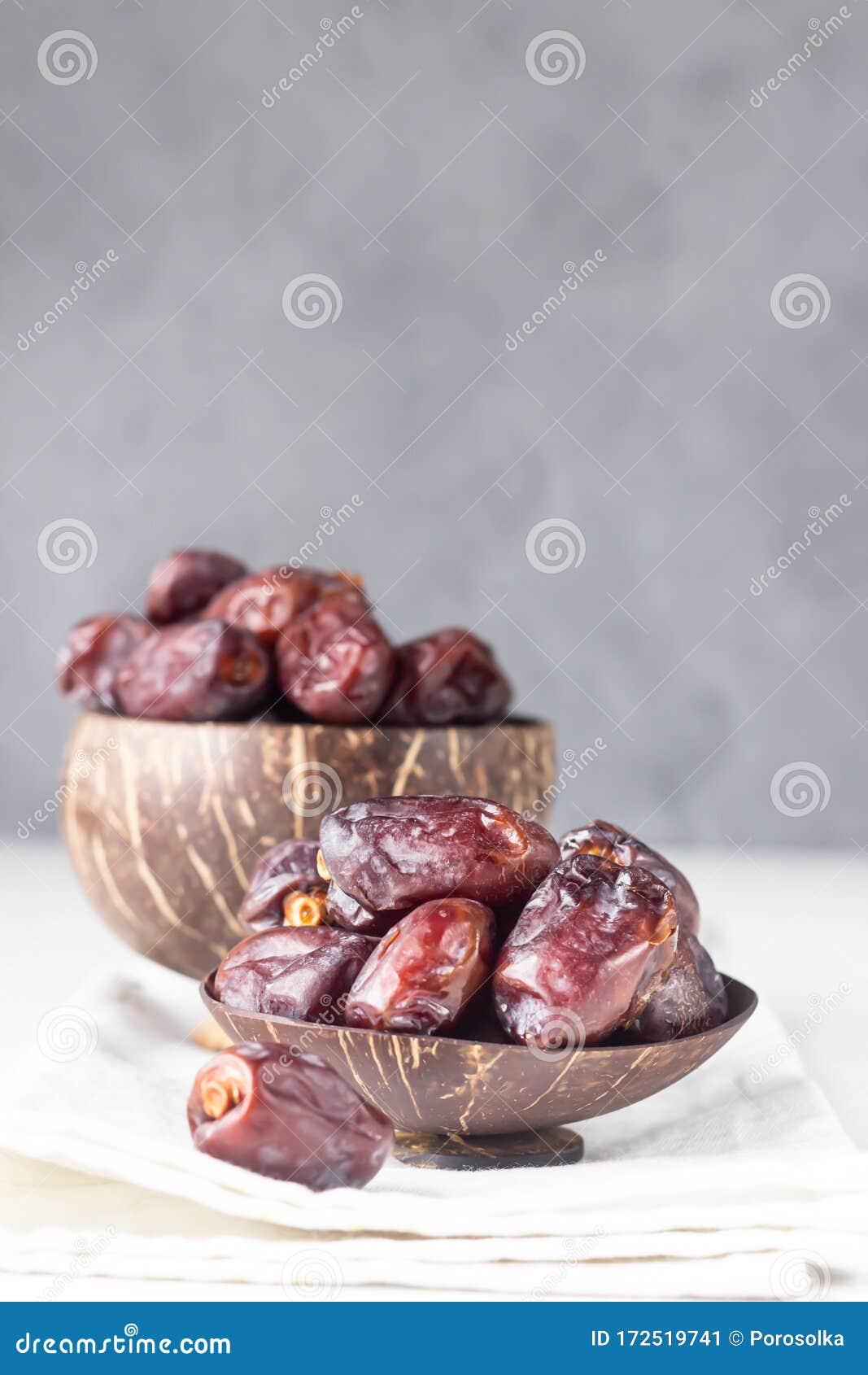 Coconut Shell with Organic Medjool Dates on a Light Grey Concrete ...