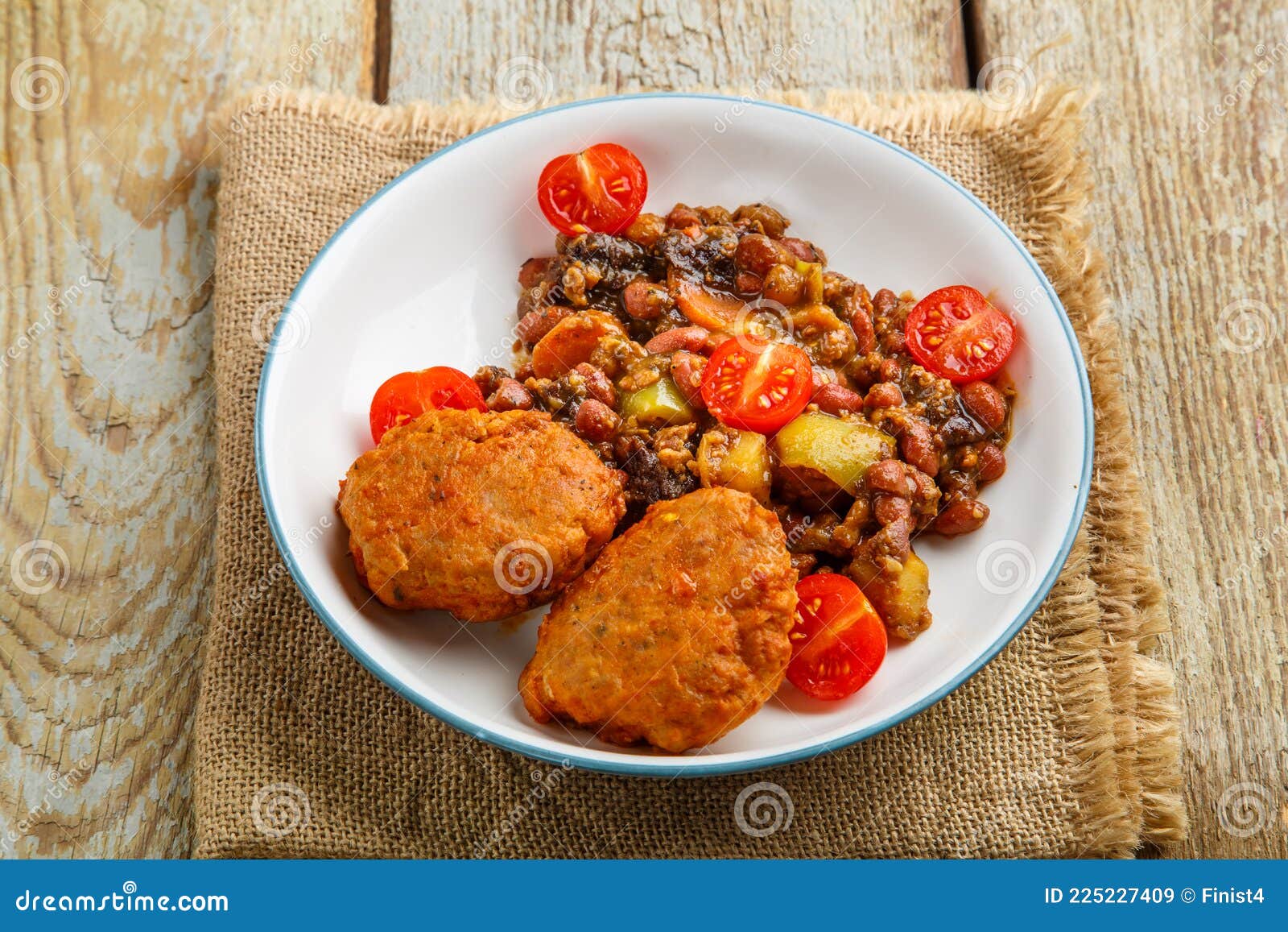 Cod Cutlets with Potatoes and Vegetables on a Plate on a Napkin. Stock ...