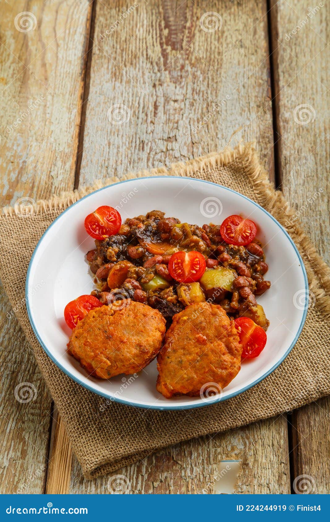 Cod Cutlets with Stewed Potatoes and Vegetables on a Plate on a Napkin ...